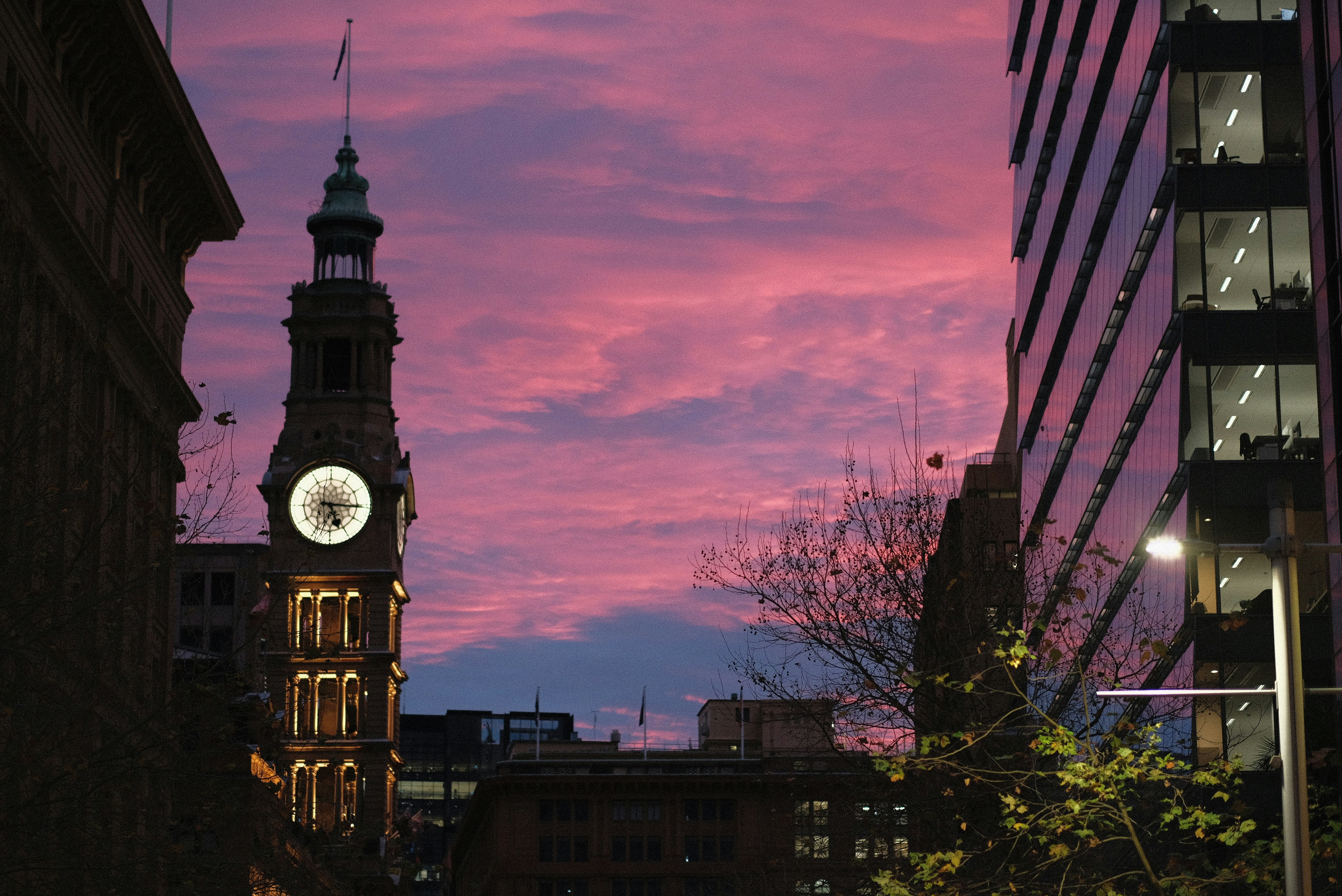 A large clock tower towering over a city at dusk photo – Free Martin ...