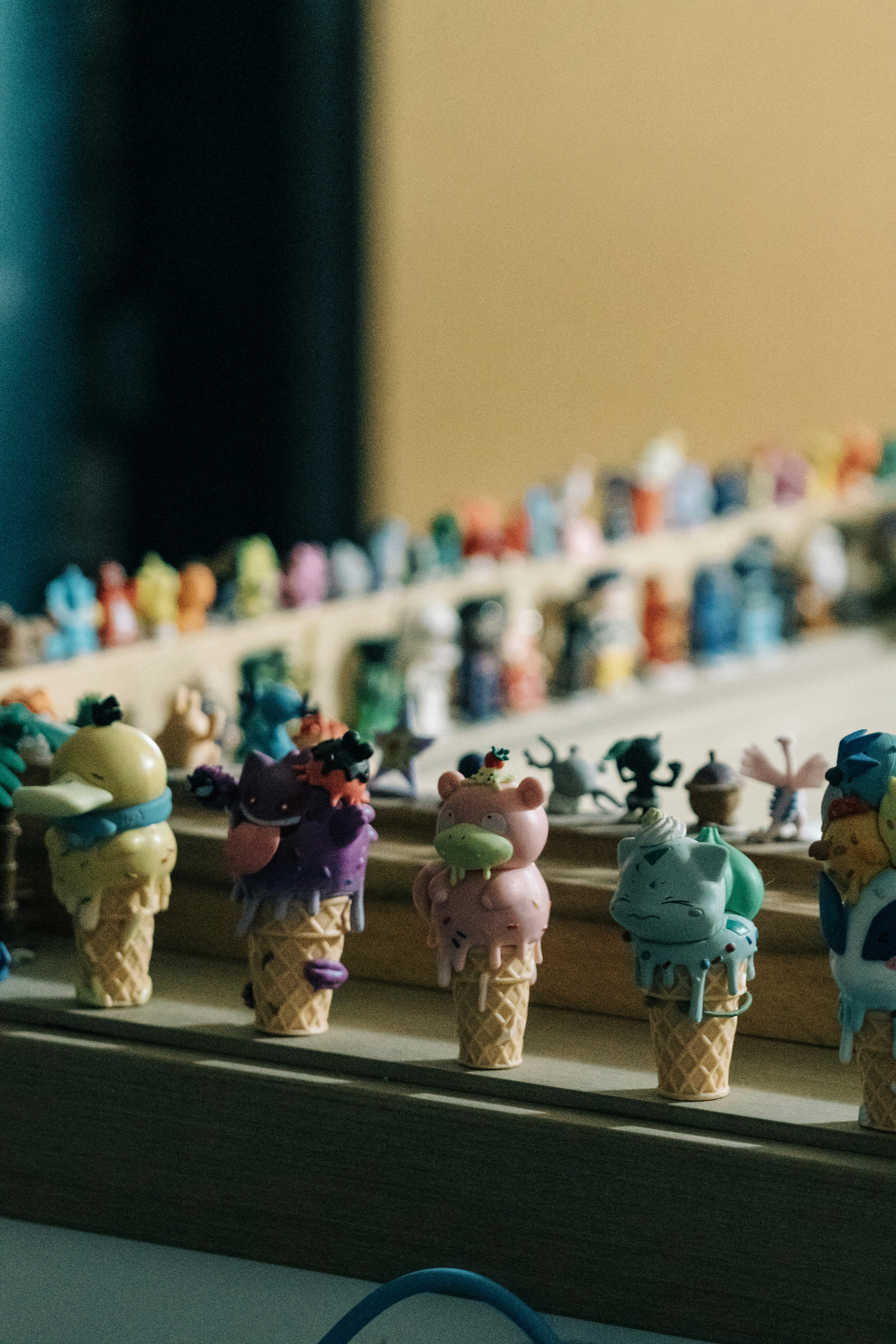 Pastel Cone Parade: Tiny Figures on a Wooden Shelf