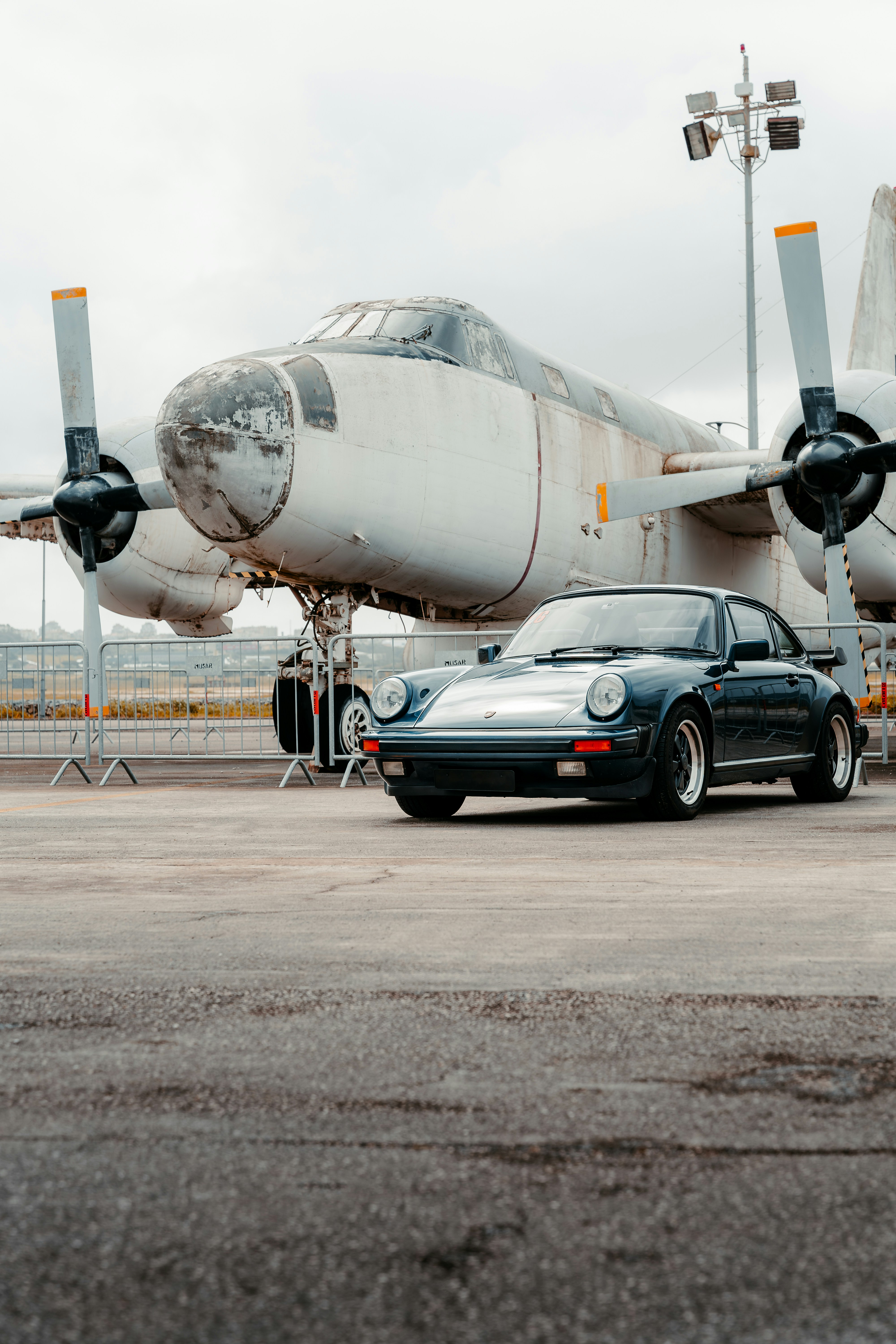 Blue Steel on Tarmac: A Porsche Confronts a Weathered Twin-Prop