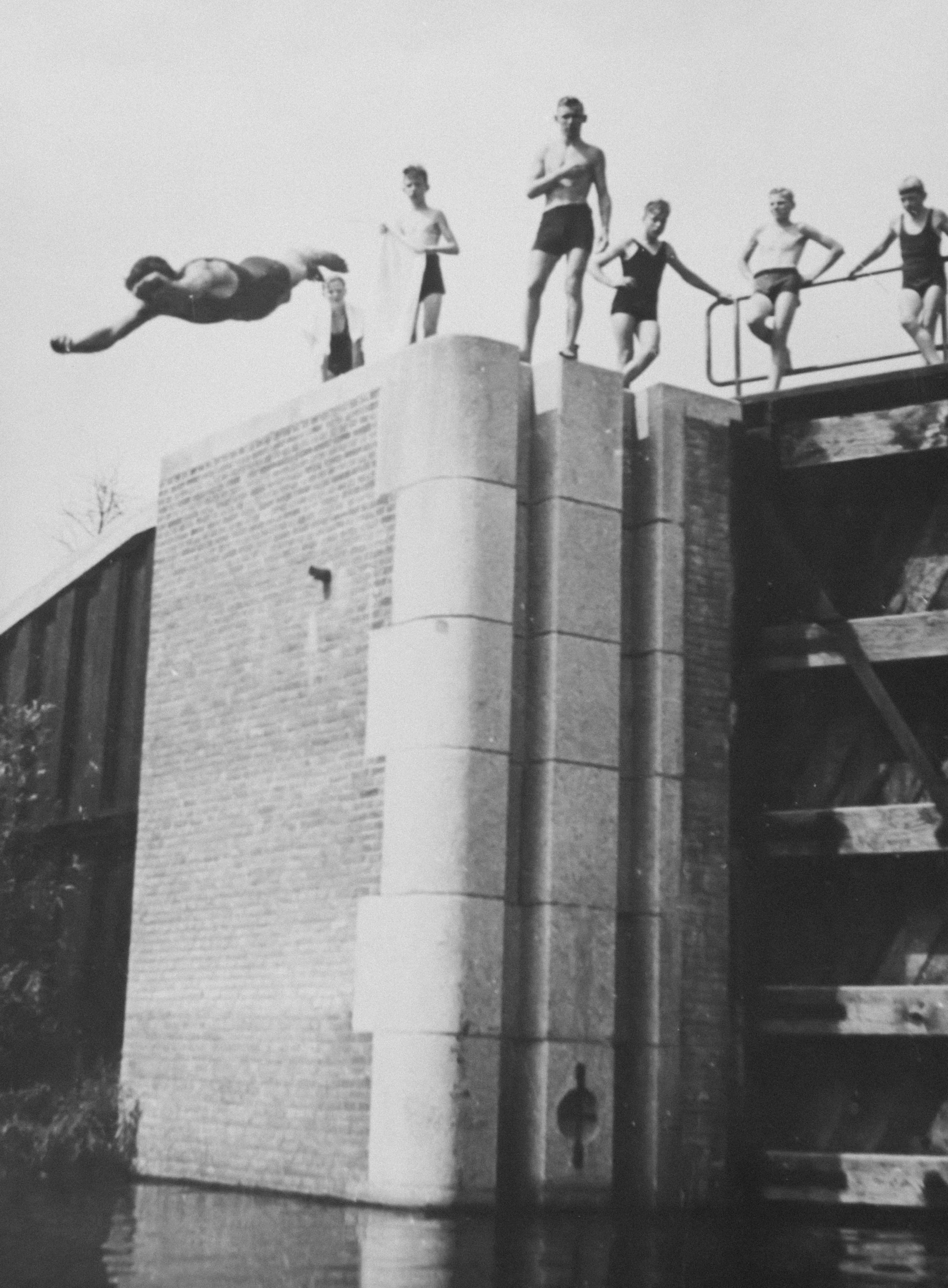 Men dive from a concrete structure into water photo – Free Amsterdam ...