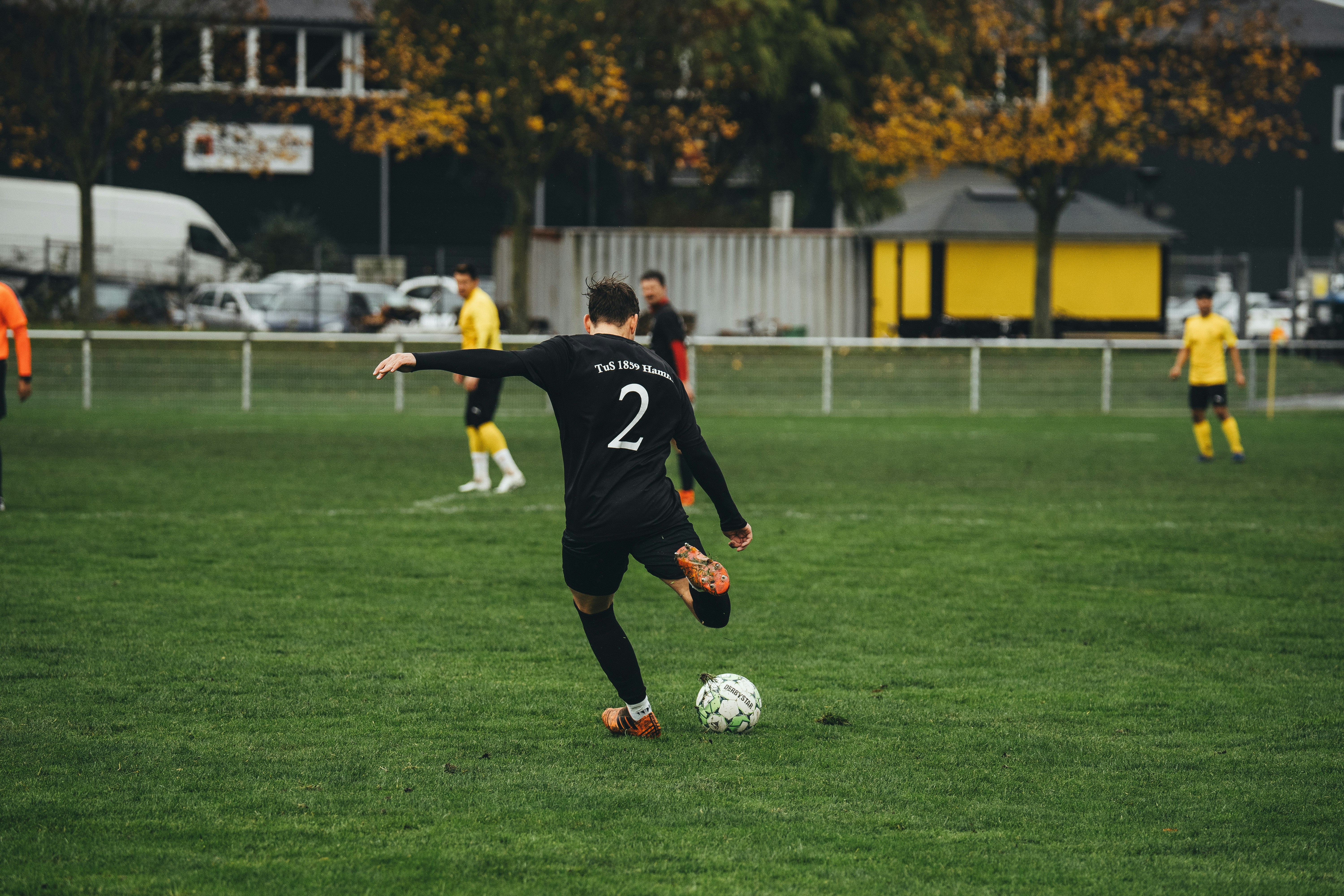 A group of young men playing a game of soccer photo – Free Football ...
