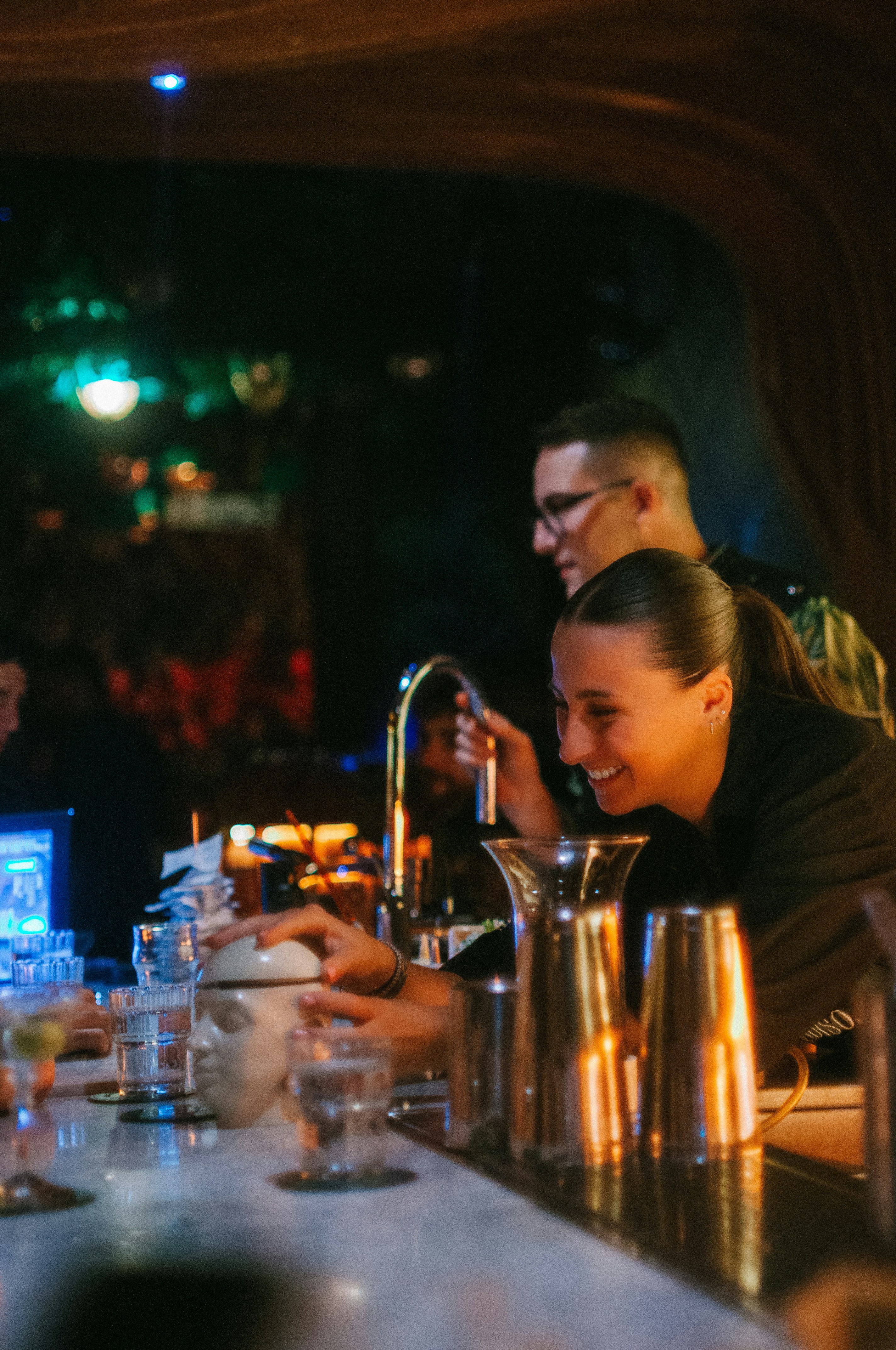 A group of people sitting at a bar photo – Free Carrer de rera palau ...