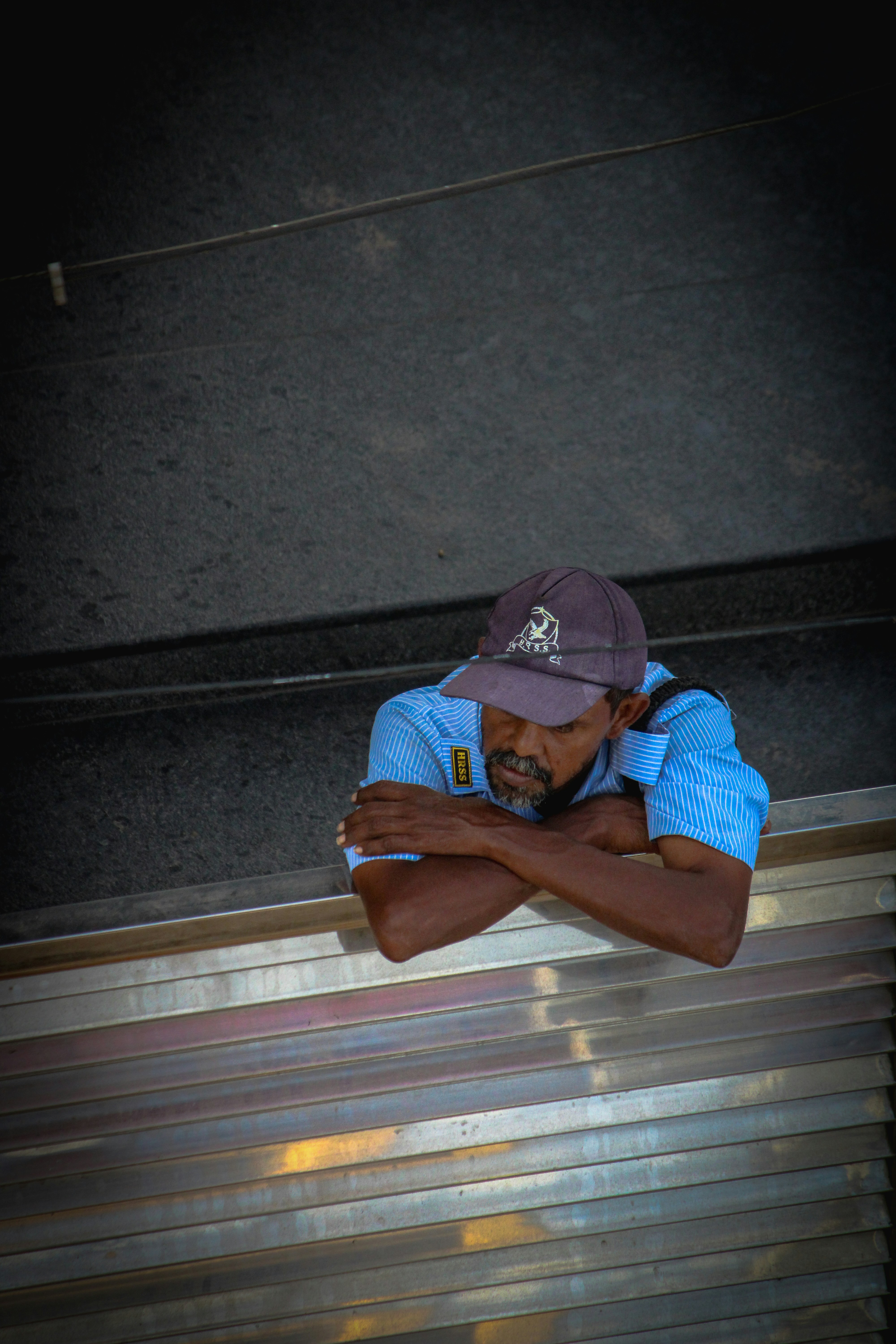 Blue Stripes on Steel: A Quiet Pause by the Railing