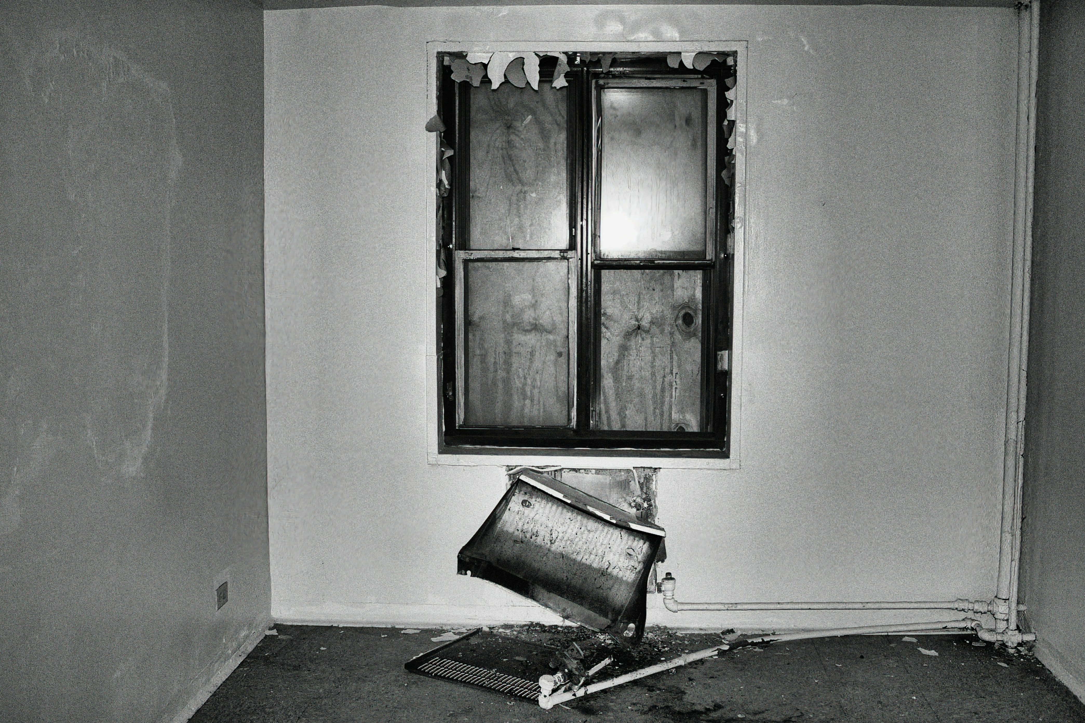 Grey Decay Under the Window: The Fallen Chair in an Abandoned Room