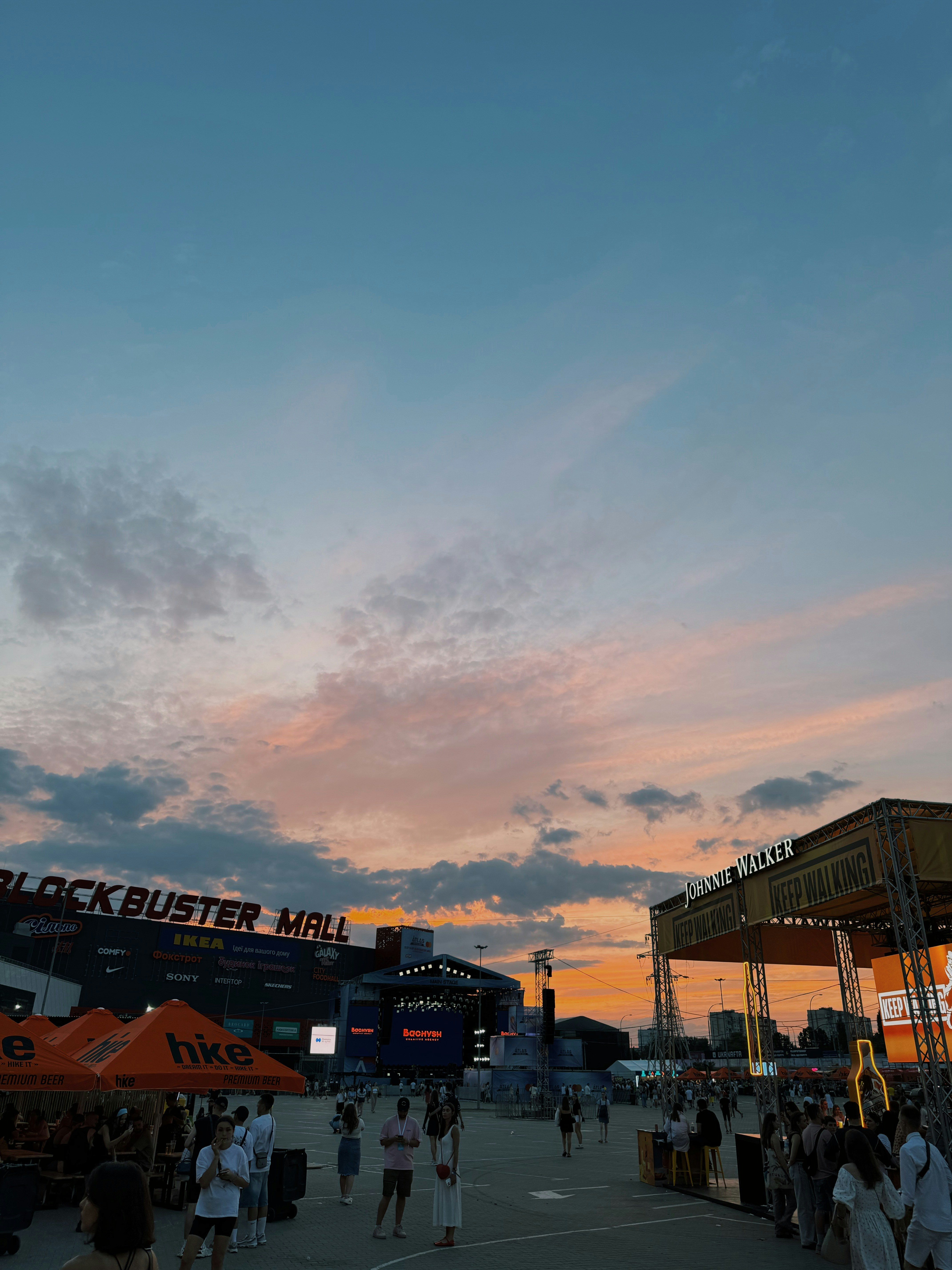 Sunset Neon on the Expo Stage: Crowds Converge Around a Luminous Event