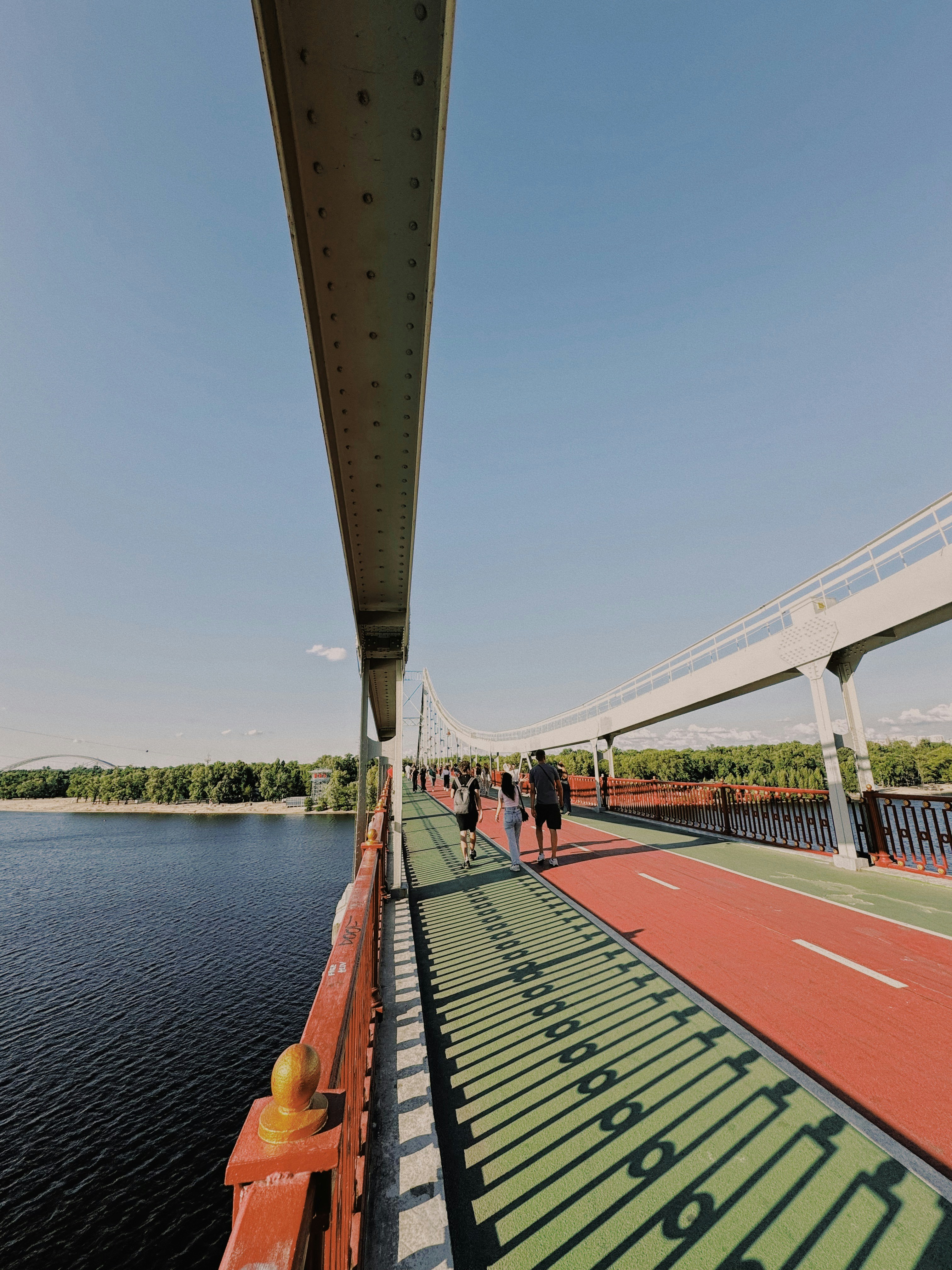 Vanishing Point on Riverside Bridge: Sunlight, Steel, and Footsteps