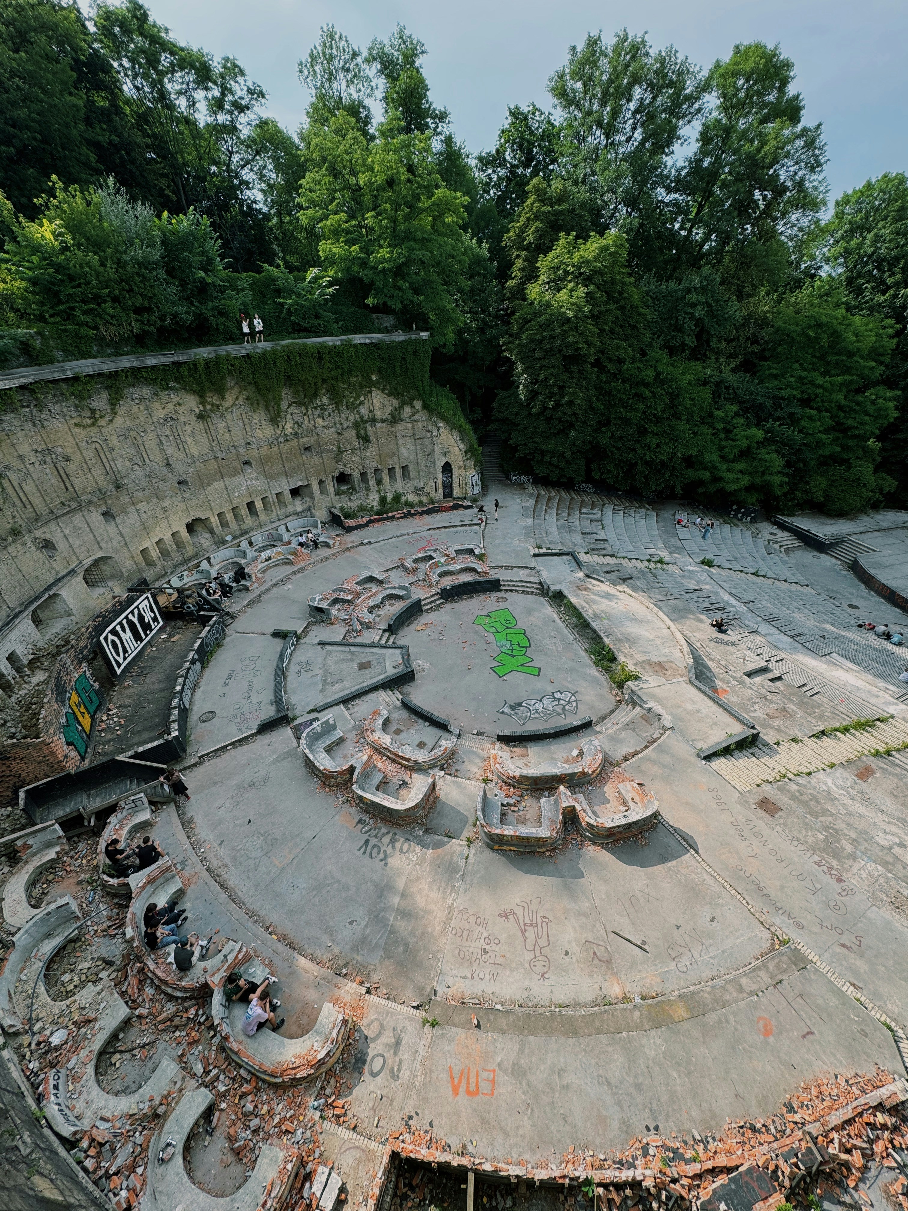 Ring of Ruins: Graffiti Center in an Abandoned Amphitheater Enveloped by Trees