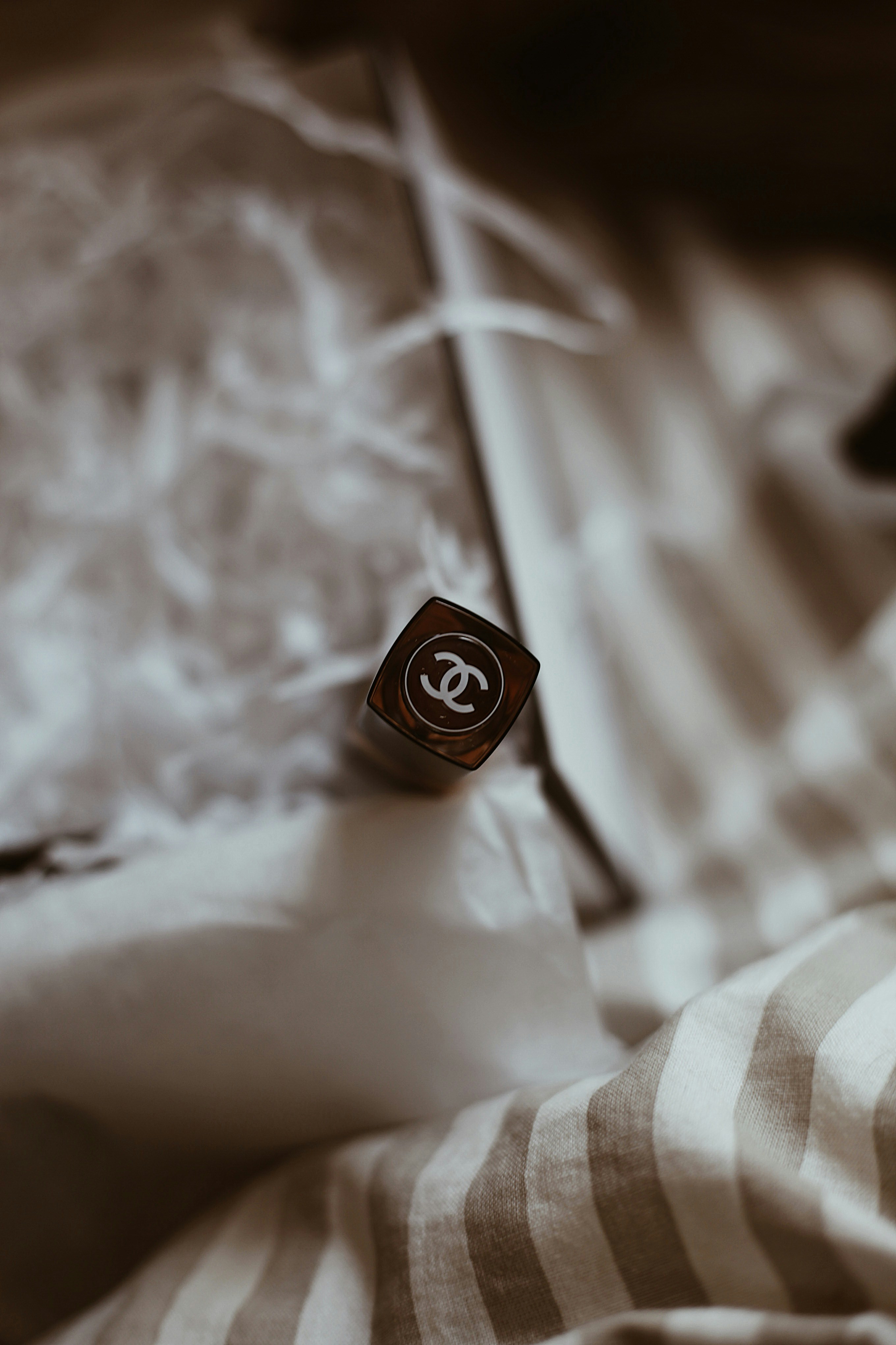 Sepia Quietude: Chanel Cap Anchored by Crumpled Fabric