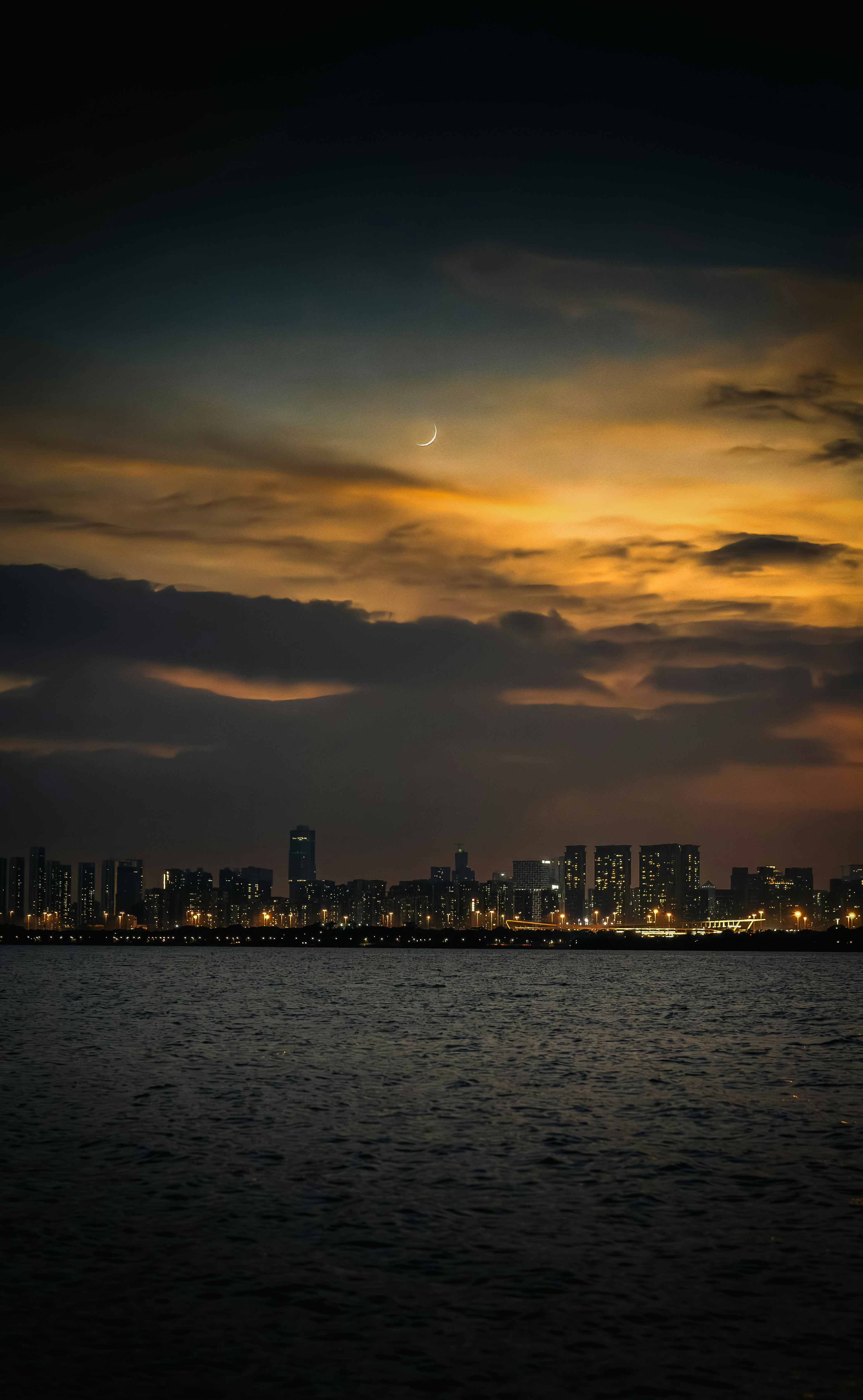 seaside city night with moon