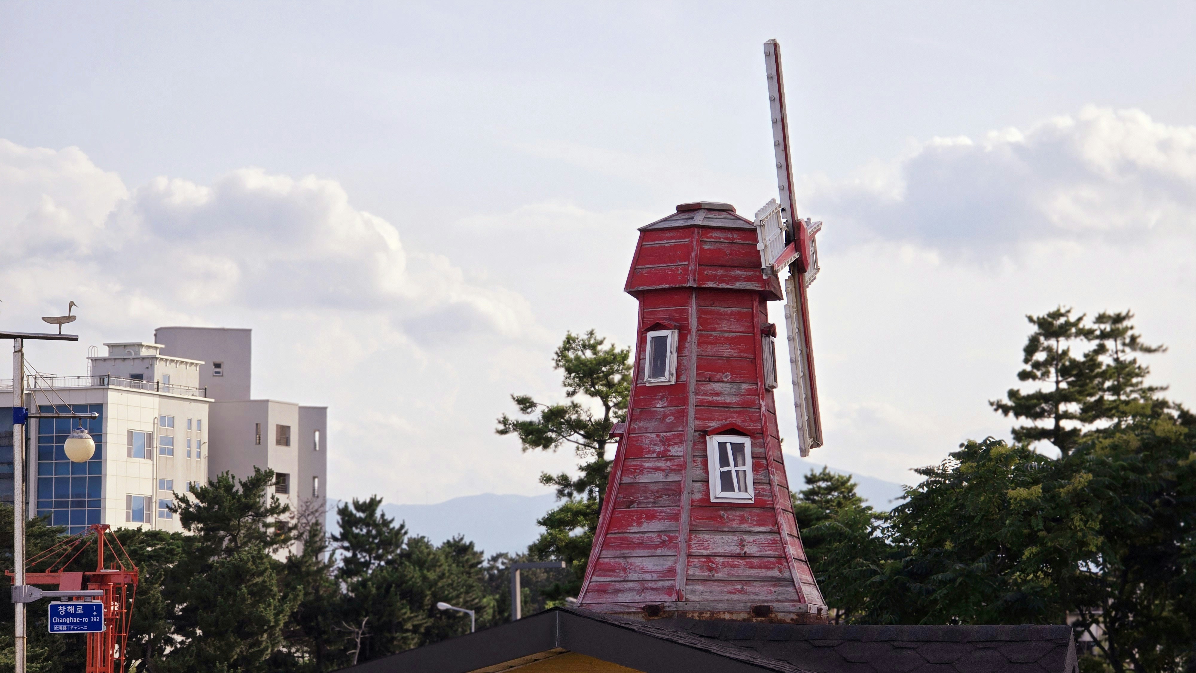 Scarlet Windmill Against a Quiet Cityscape