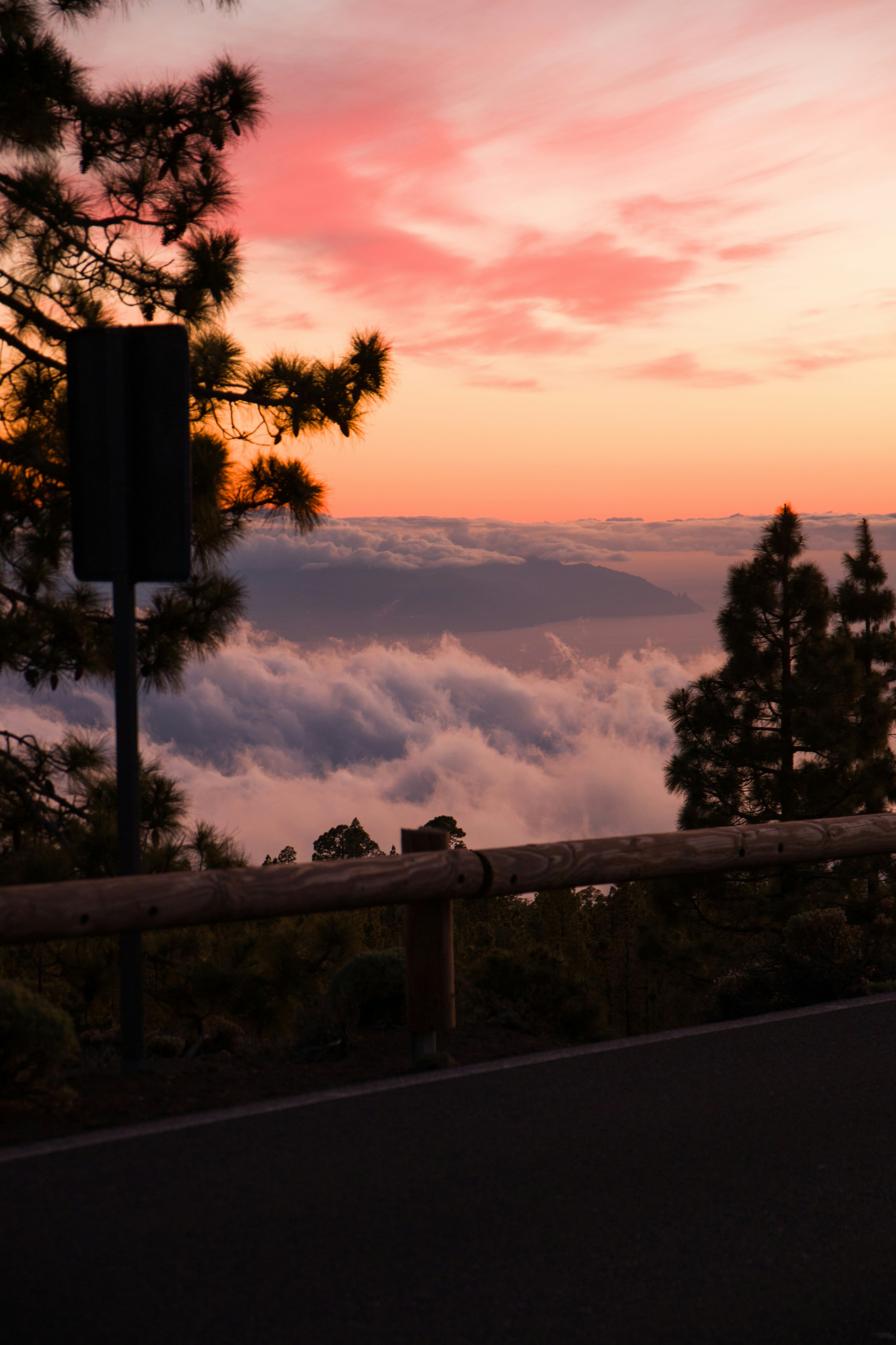 Guardrail at the Rim: Sunset over a Sea of Clouds