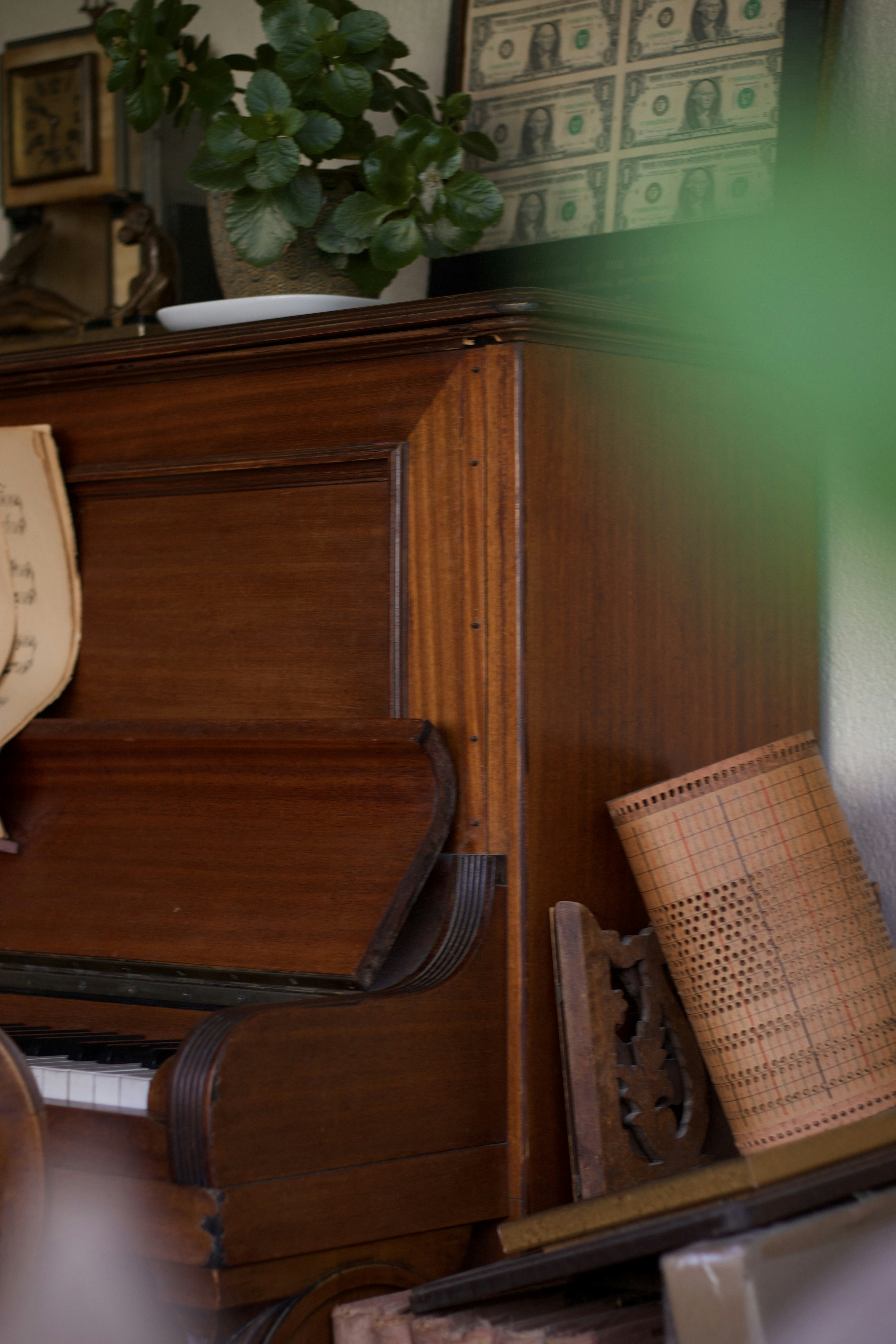 Antique piano nestled among vintage decor and greenery, evoking a sense of nostalgia. The scene captures a blend of musical heritage and timeless charm.
