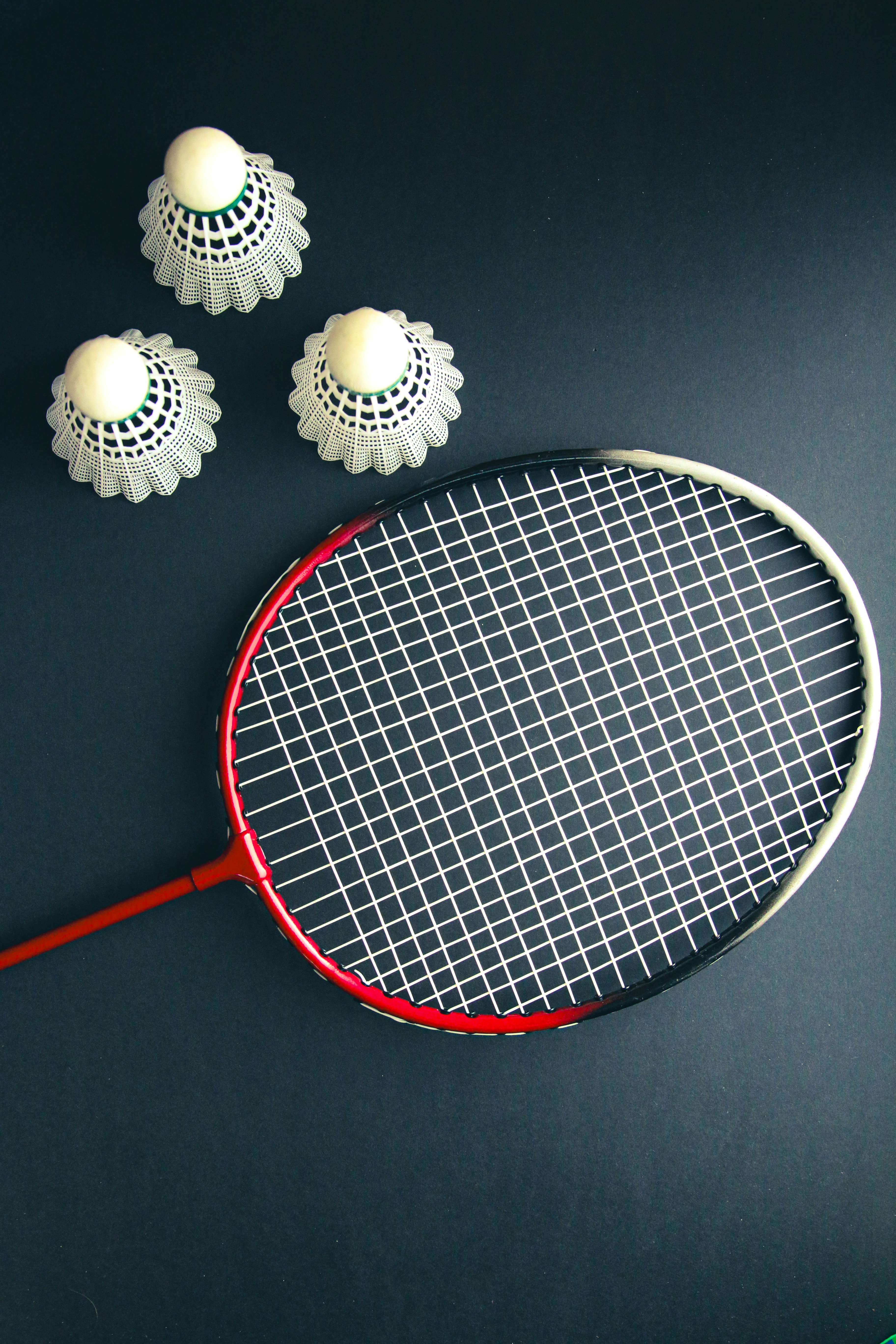 A tennis racket and four balls on a table photo – Free Racket Image on ...
