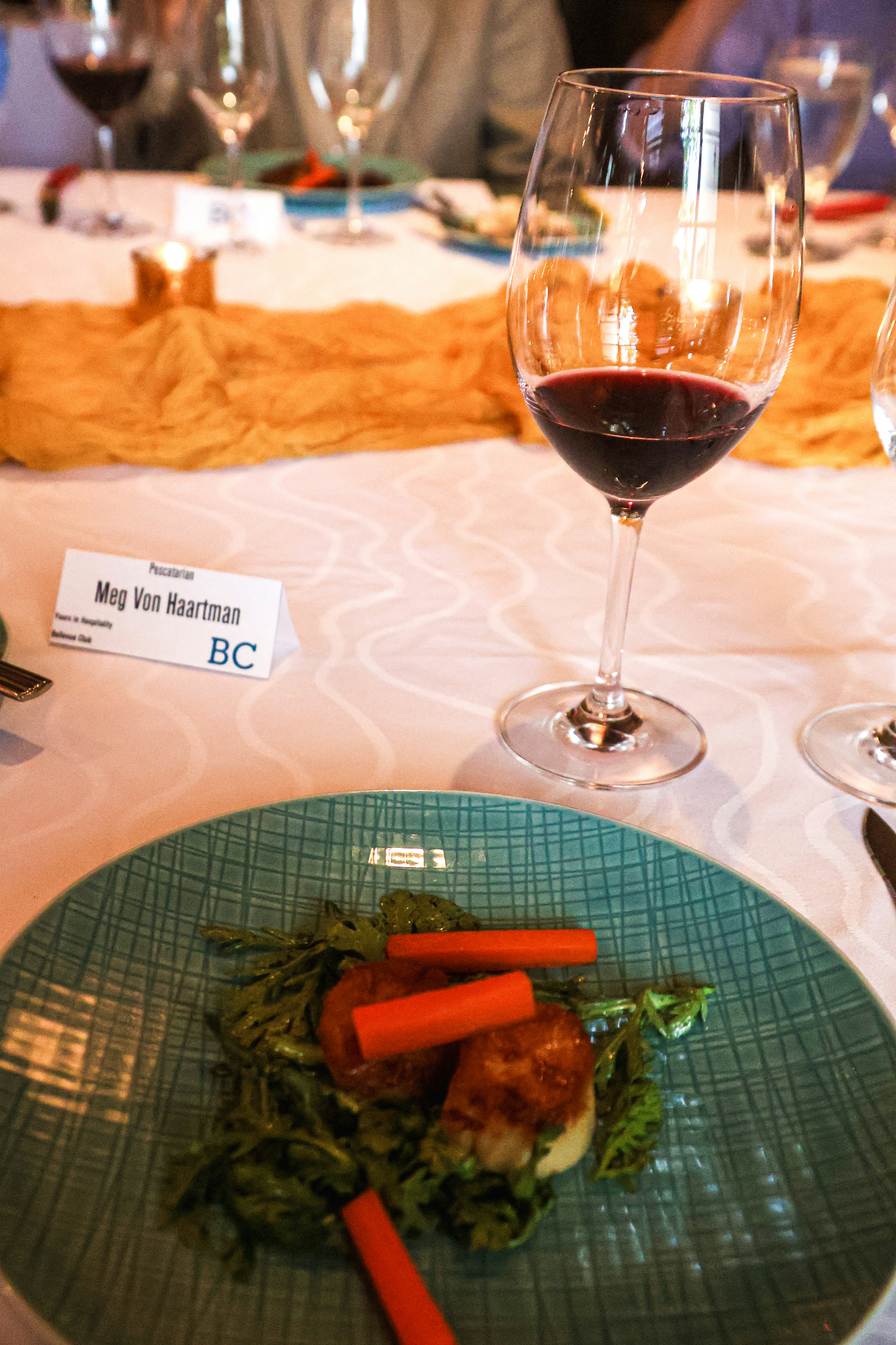Wine Glass Over a Gourmet Plate at a Formal Dinner
