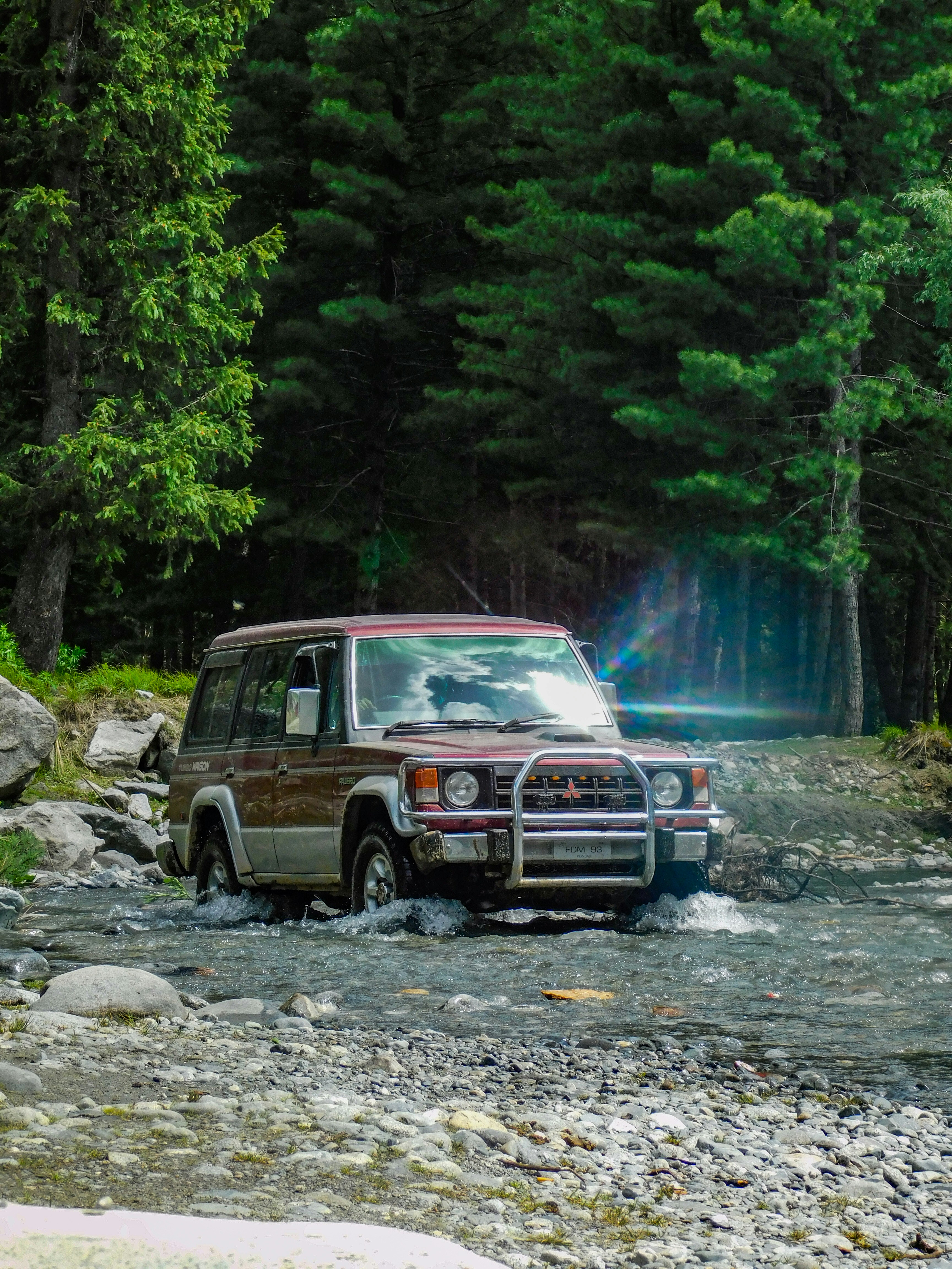 Rugged River Crossing: A Classic SUV Tames a Forest-Stream Challenge