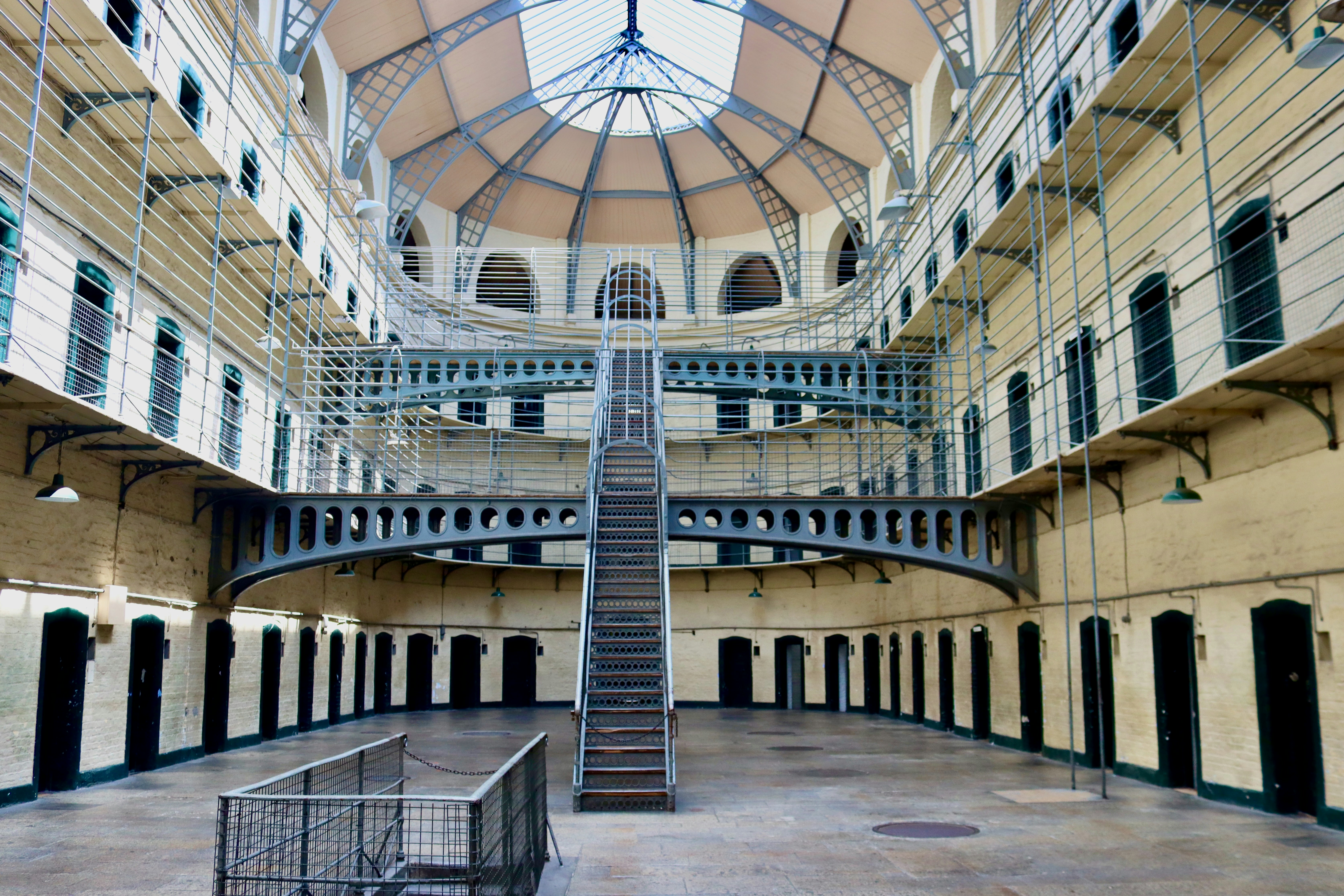 Iron Spine: Central Staircase Anchors an Atrium of Arches
