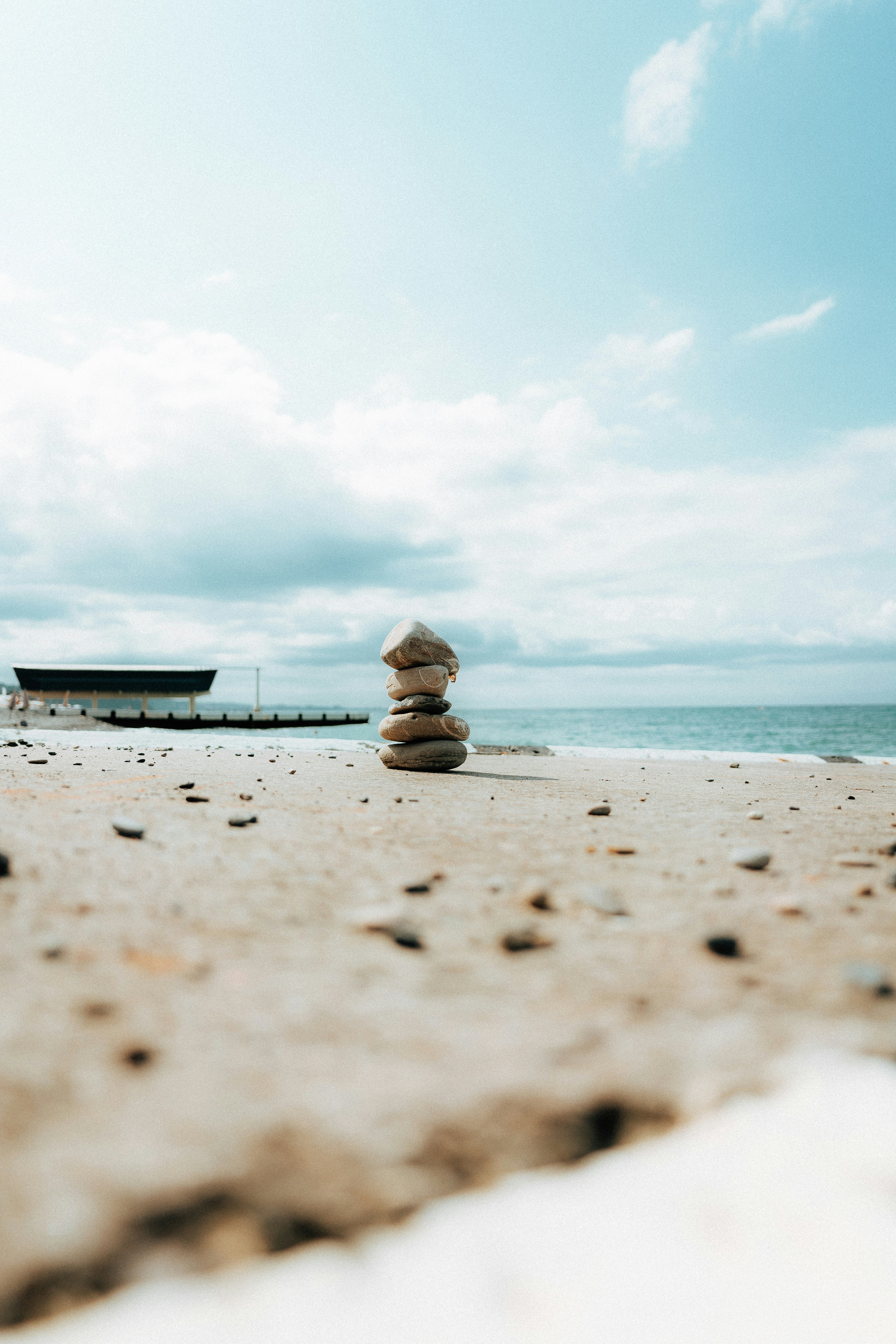 A stack of rocks sitting on top of a sandy beach photo – Free Sochi ...