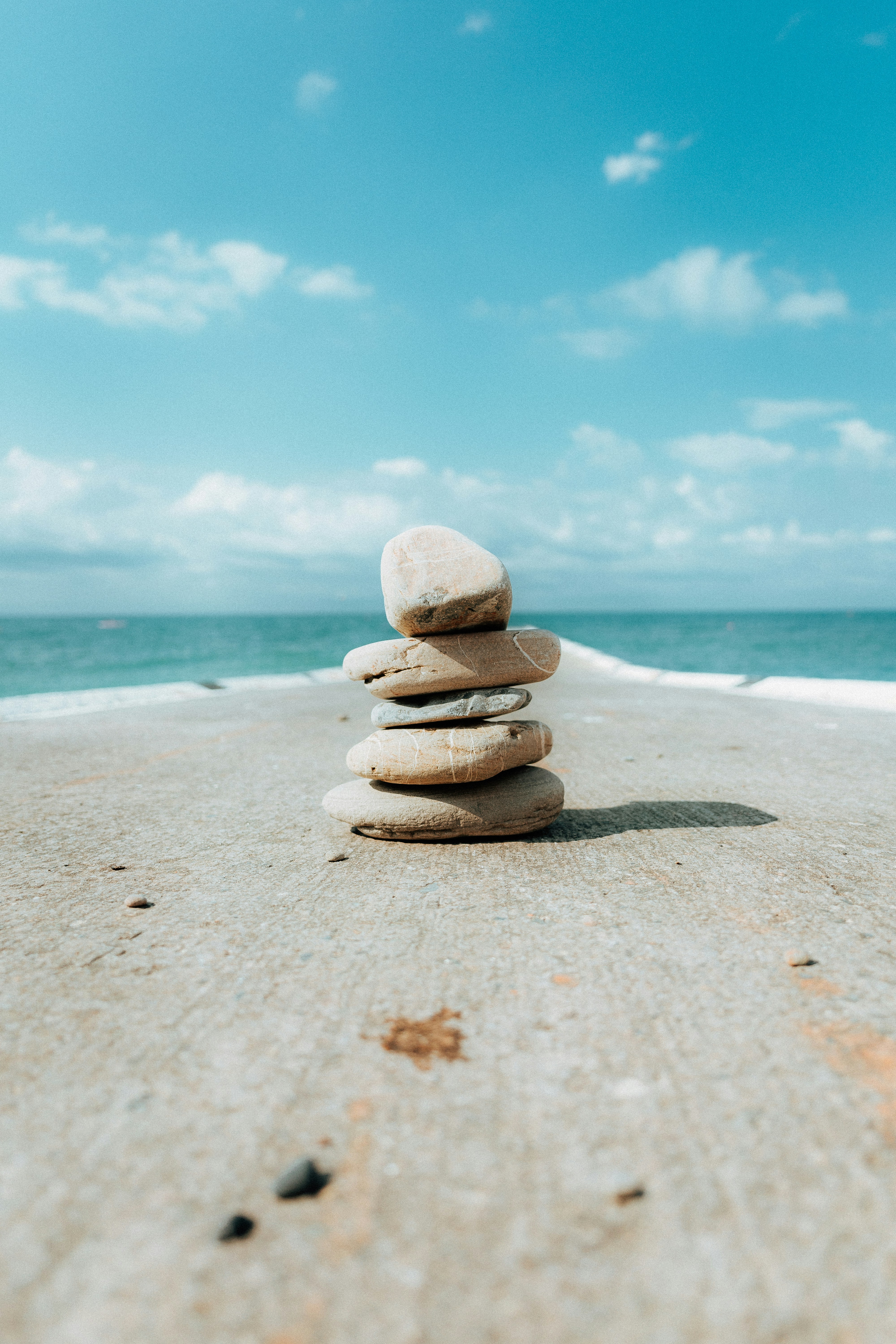 A stack of rocks sitting on top of a sandy beach photo – Free Sochi ...