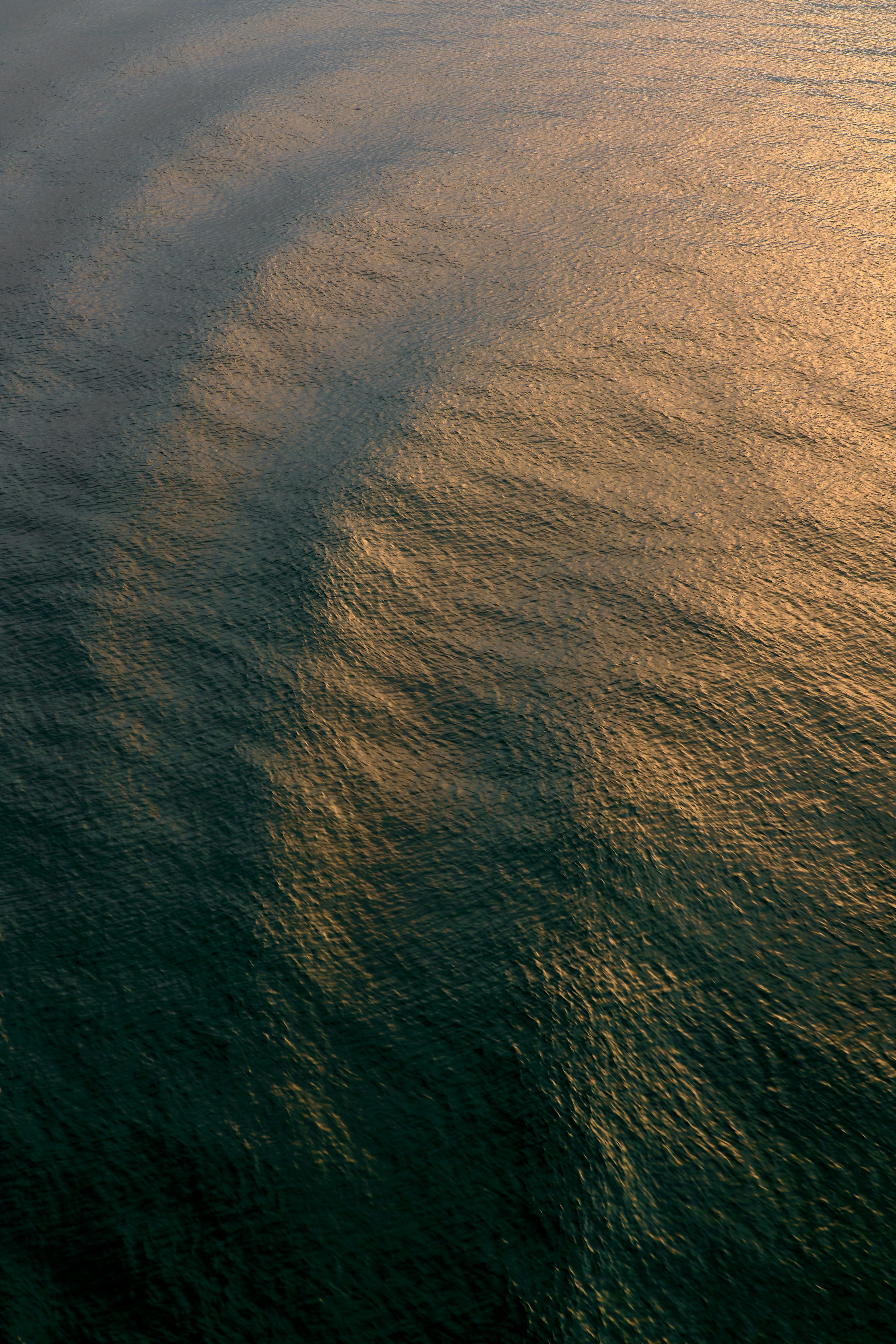 Golden Wake: Aerial Study of Sunlit Water Ripples