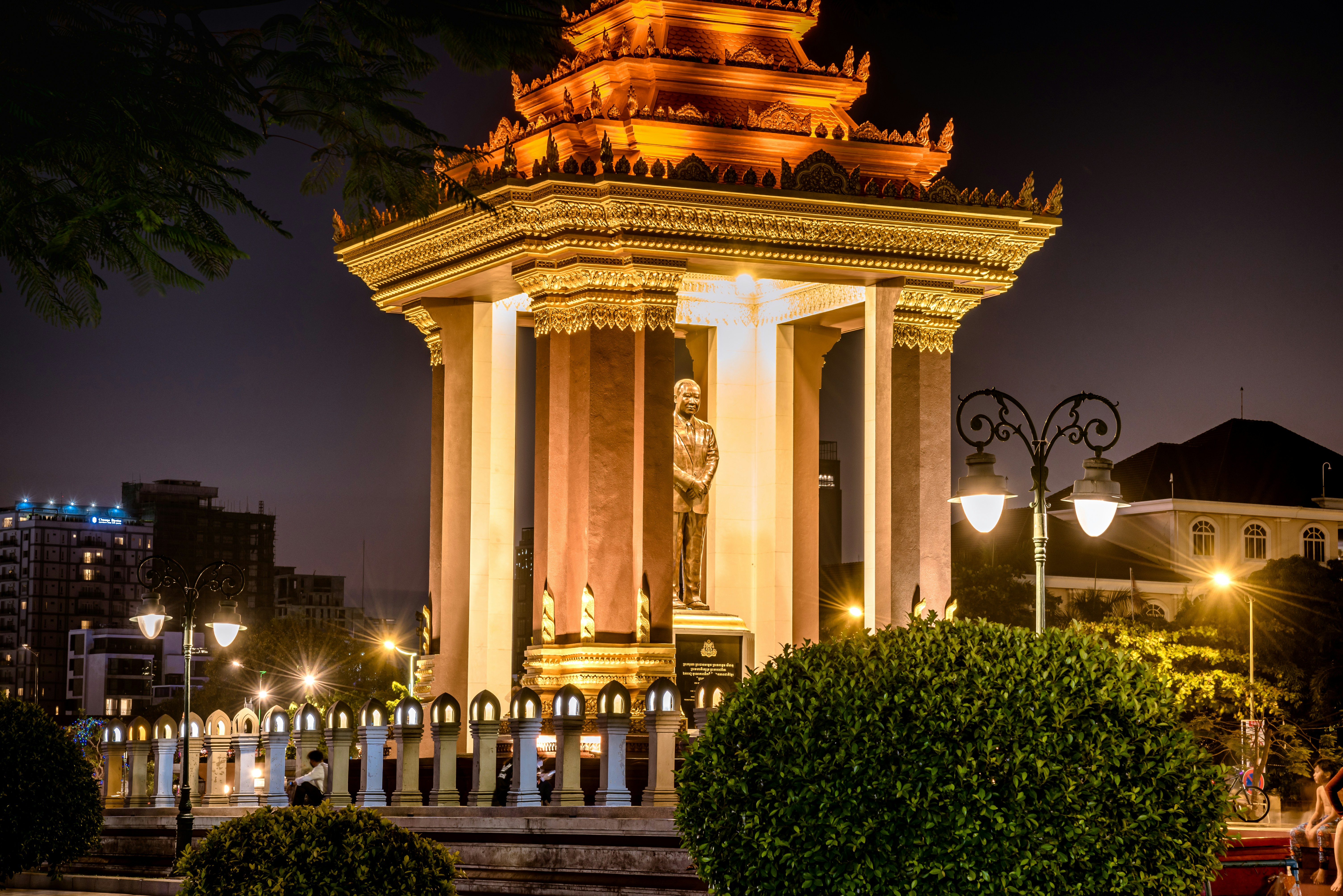 Golden Monument at Night: Illuminated Columned Shrine Rising Over a Moonlit Square