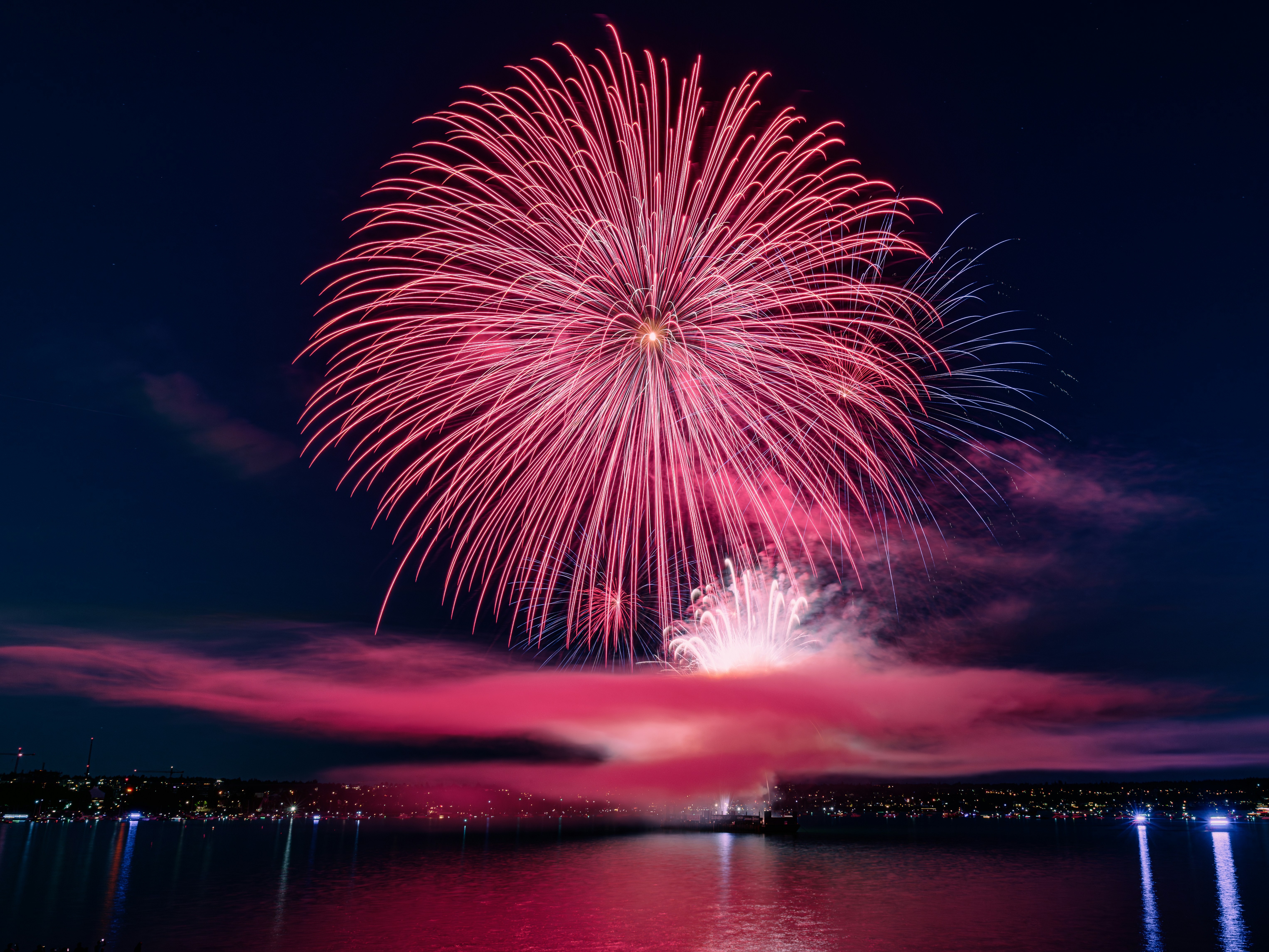 A fireworks display over a body of water photo – Free Fireworks Image ...