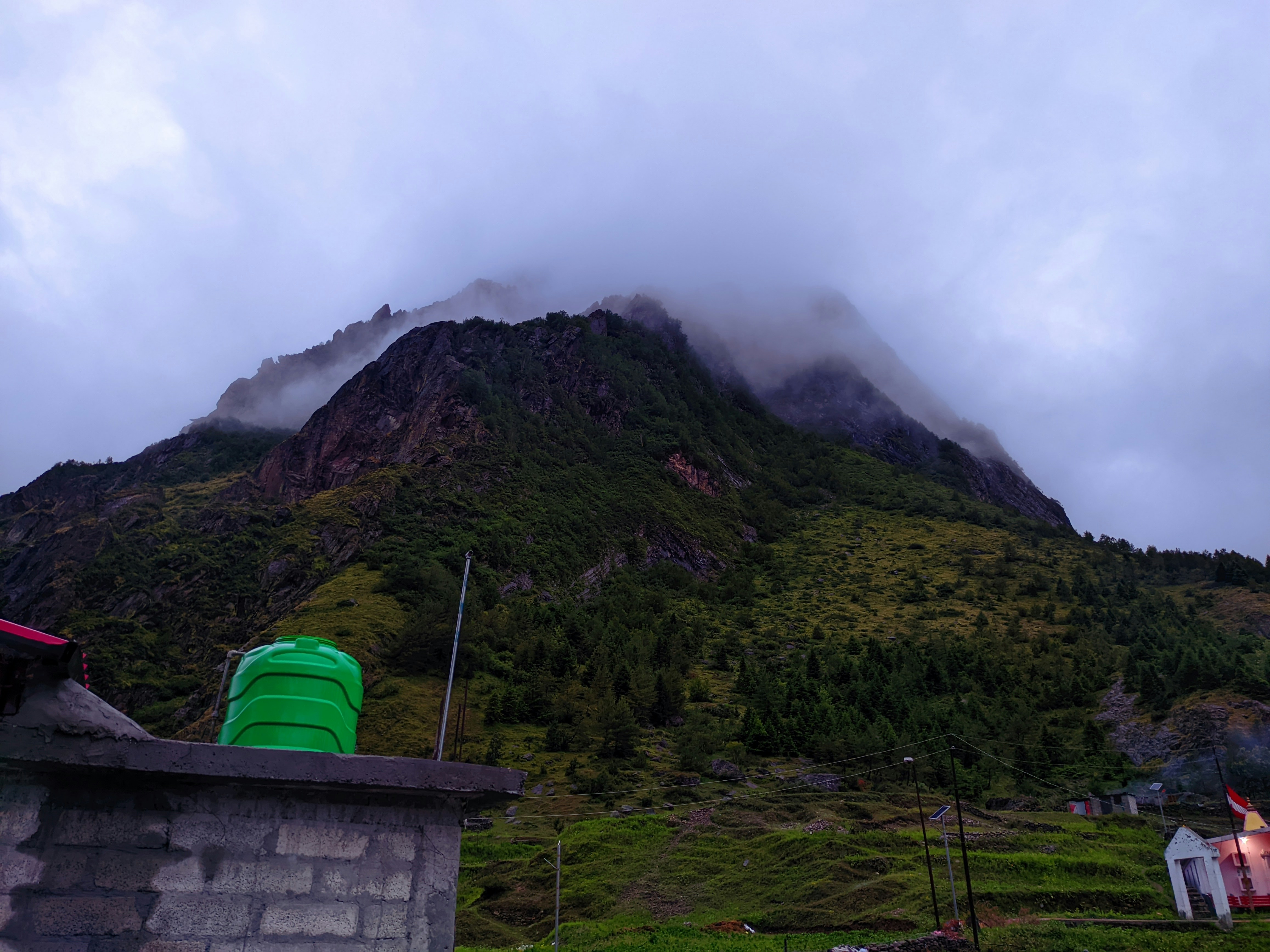 Mist-Guarded Summit Over Terraced Green Valleys