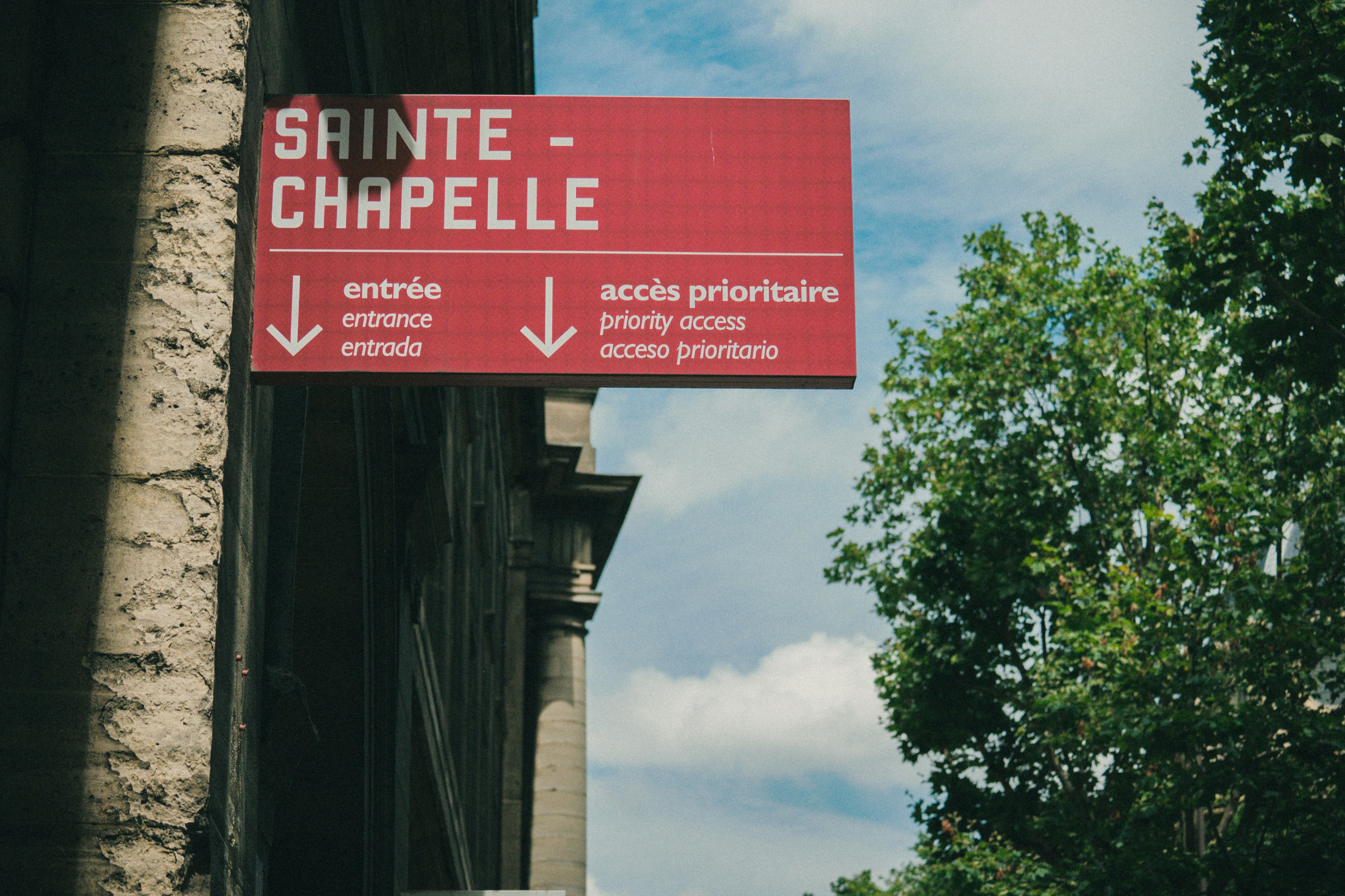 A red street sign hanging from the side of a building photo – Free ...