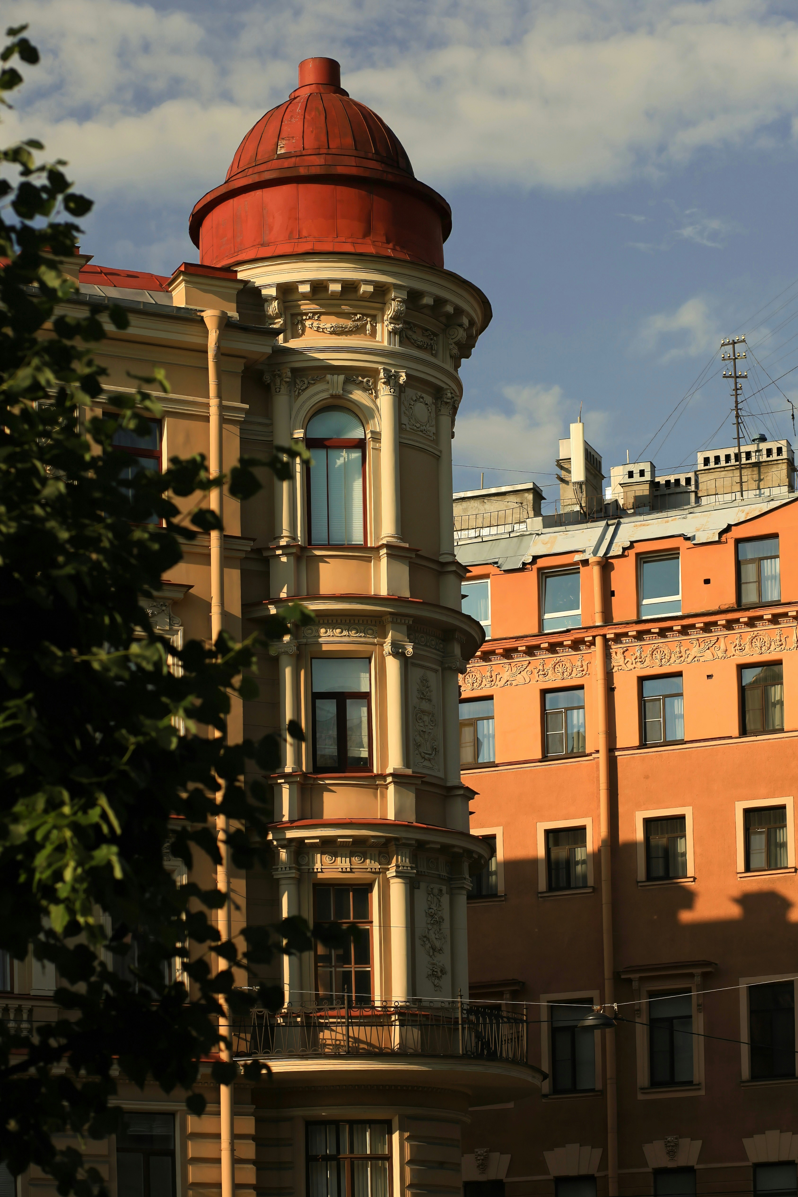 Sunlit Red-Domed Turret Anchoring a Corner of Ornate Facades