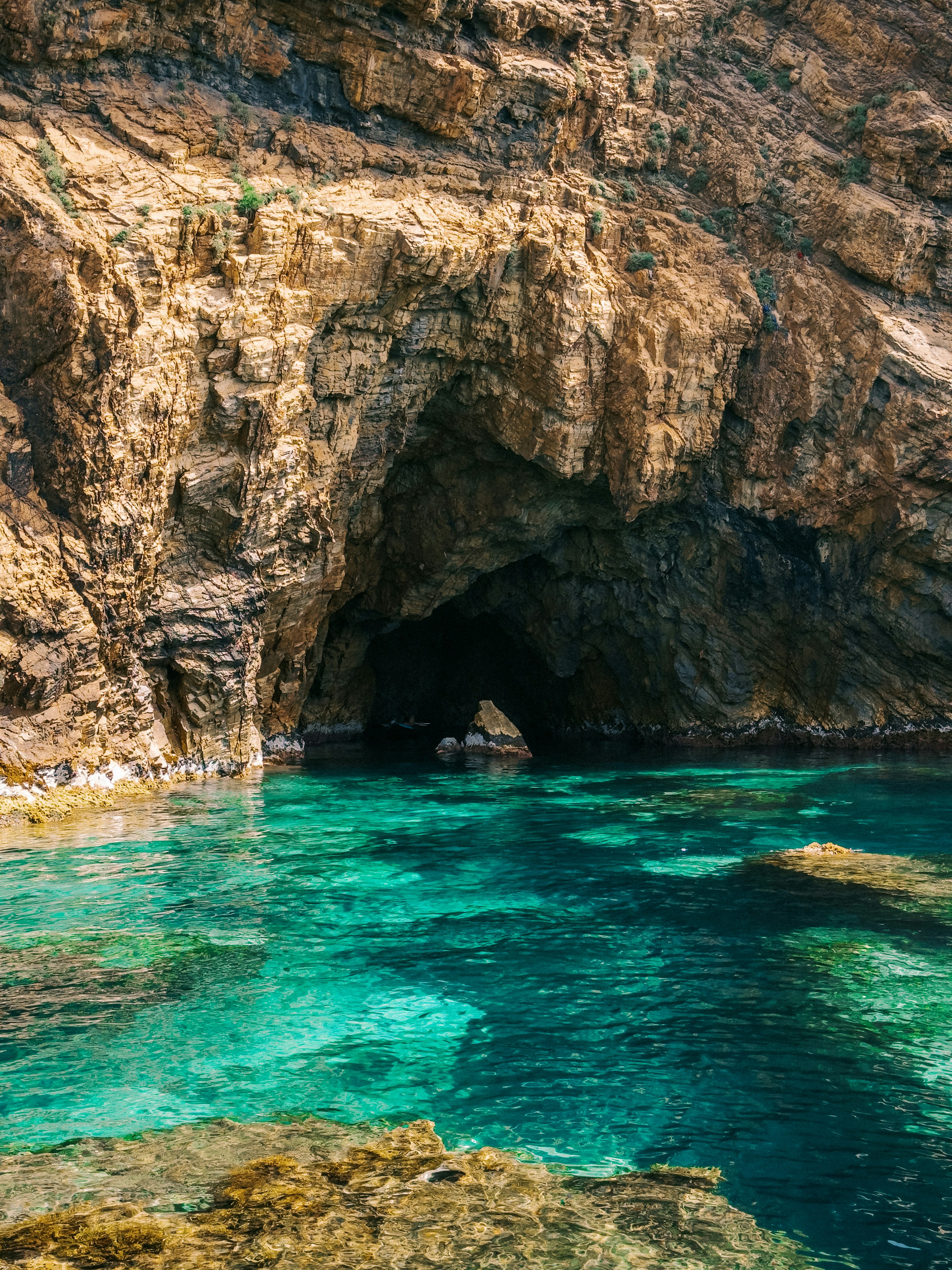 A large cave with a blue pool in the middle of it photo – Free Algeria ...