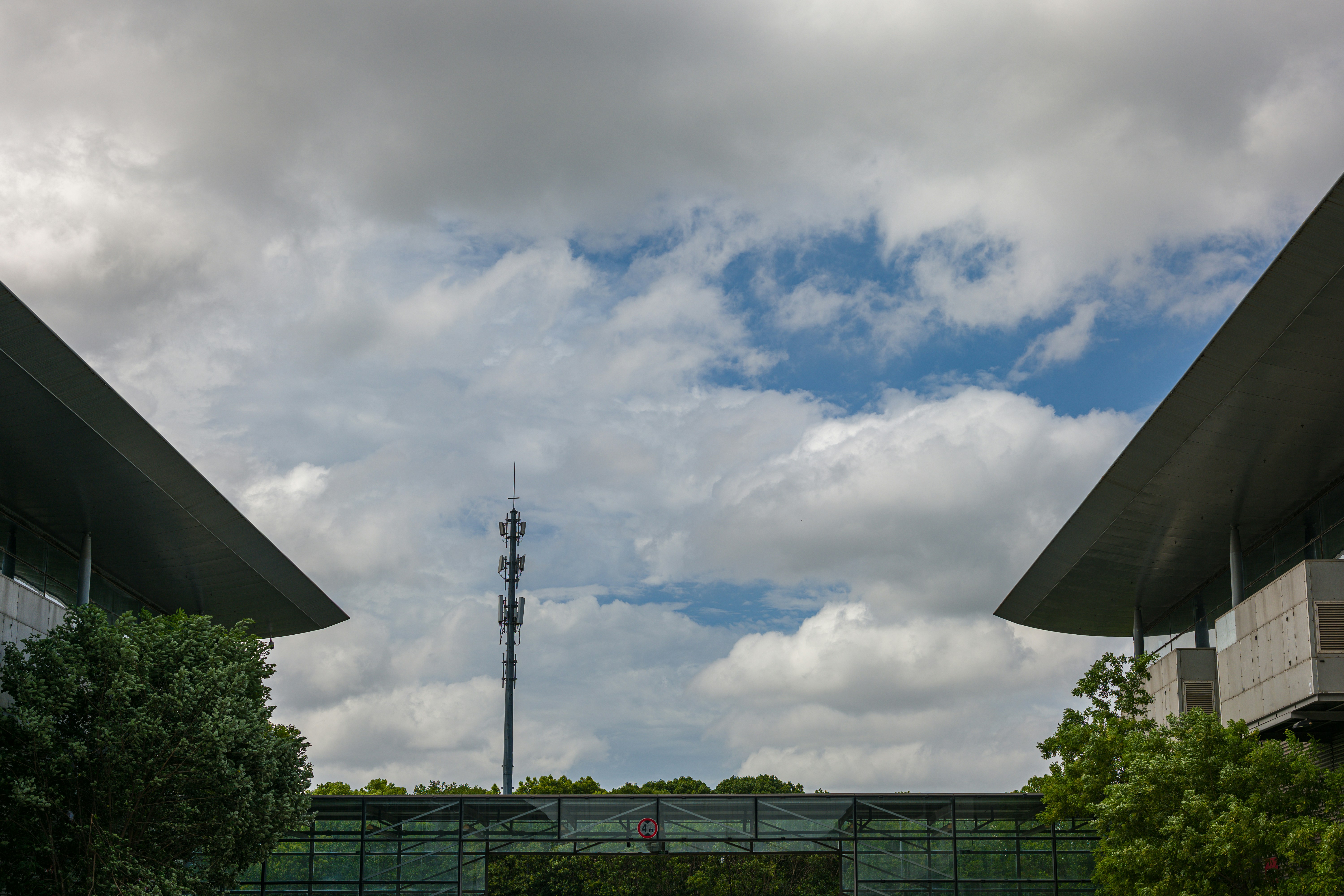 Skyward Nexus: Central Mast Framed by Modern Wings