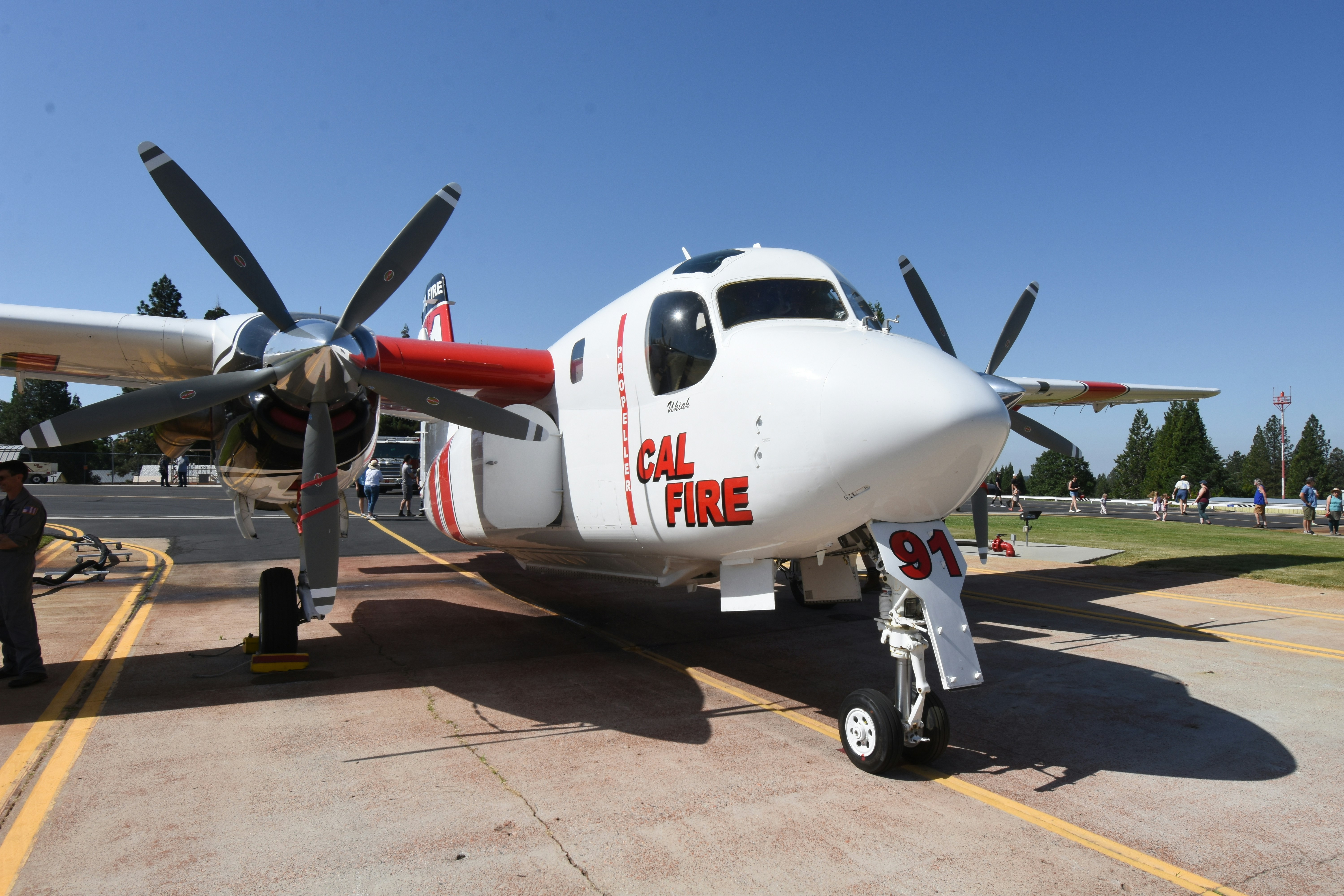 CalFire plane stationed at Grass Valley airport under clear blue skies.