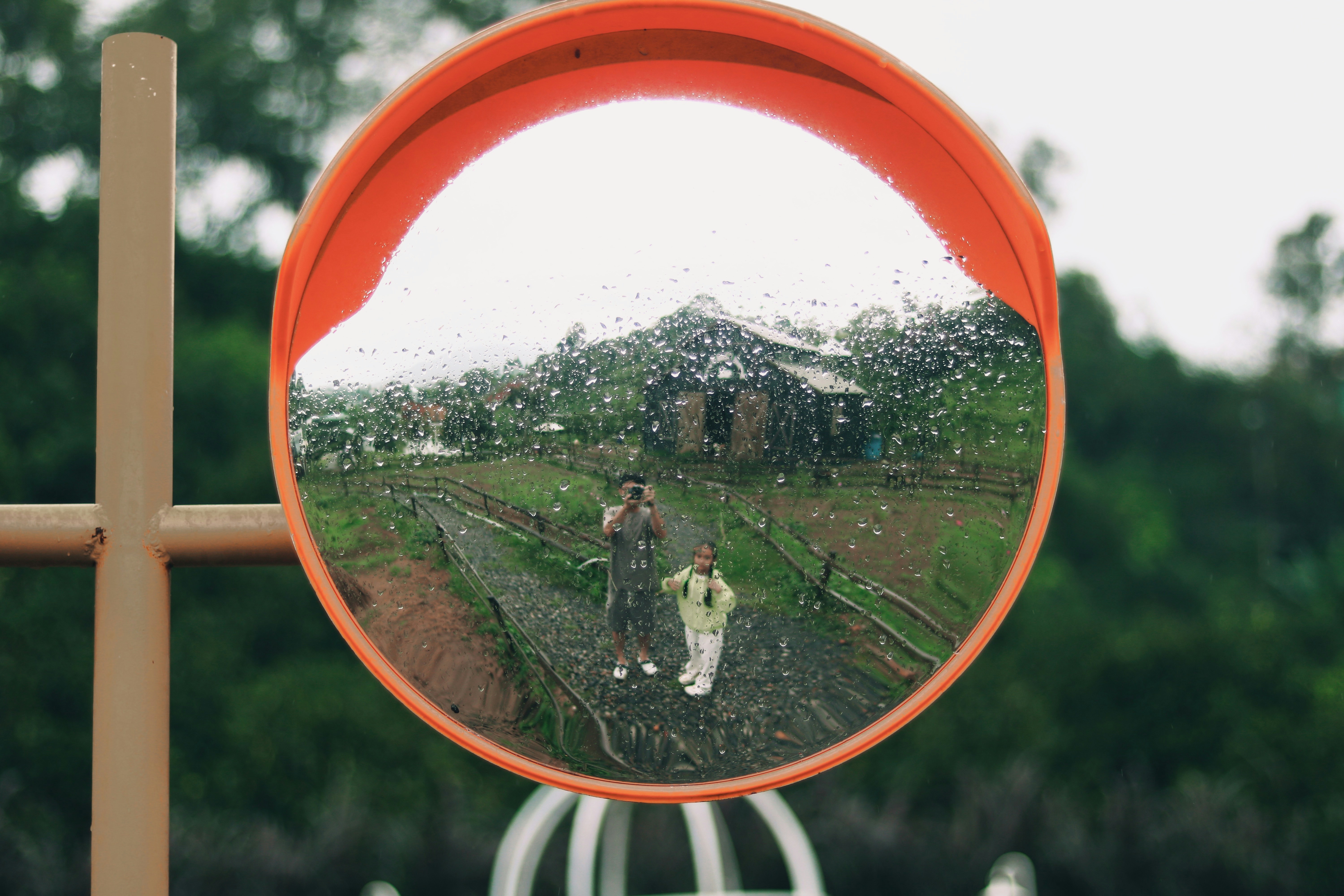 Rain-Dotted Circle: Two Figures on the Quiet Rails