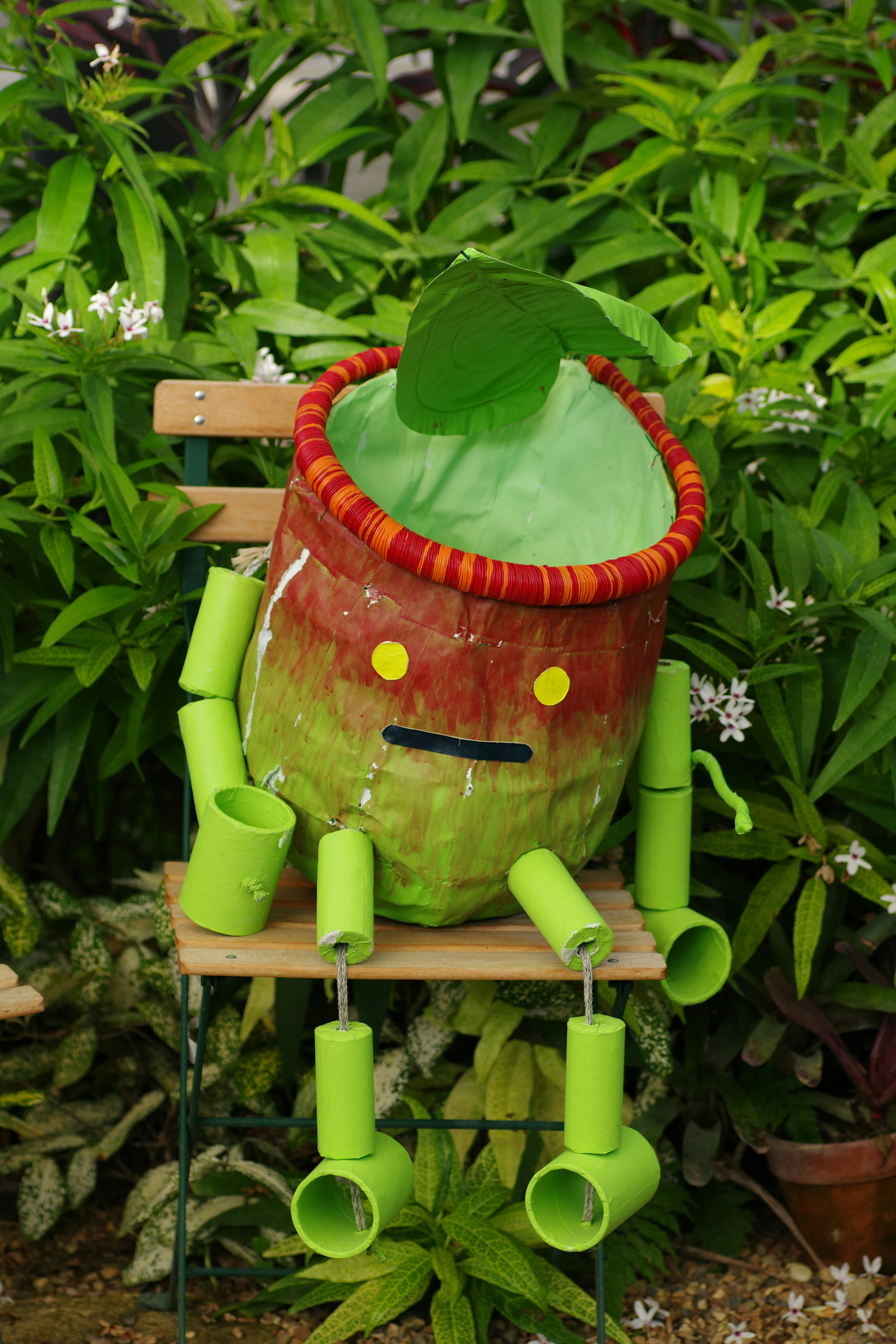 Whimsy on a Bench: A Painted Pot Robot in the Garden