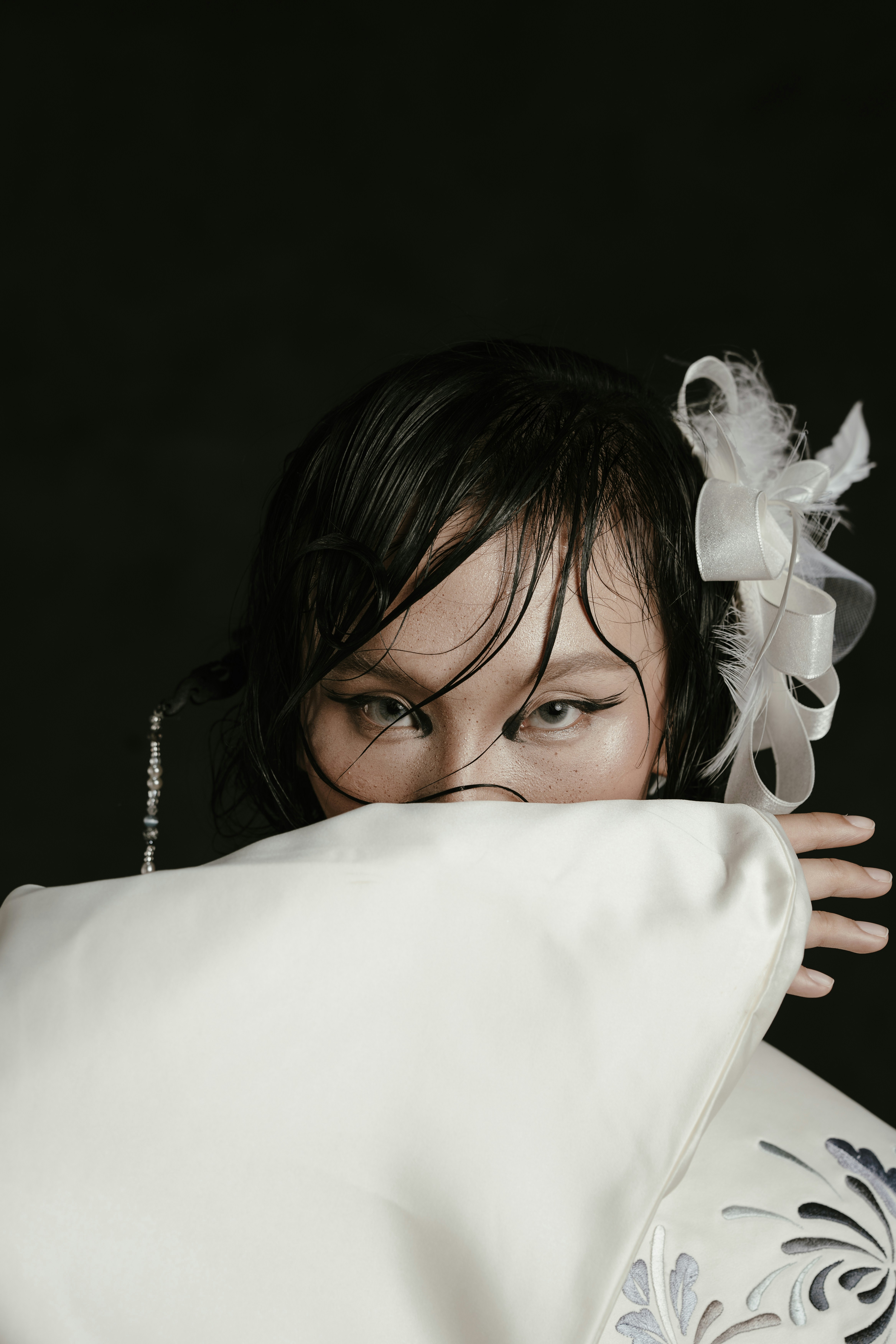 A woman hiding her face behind a pillow photo – Free Portrait Image on ...