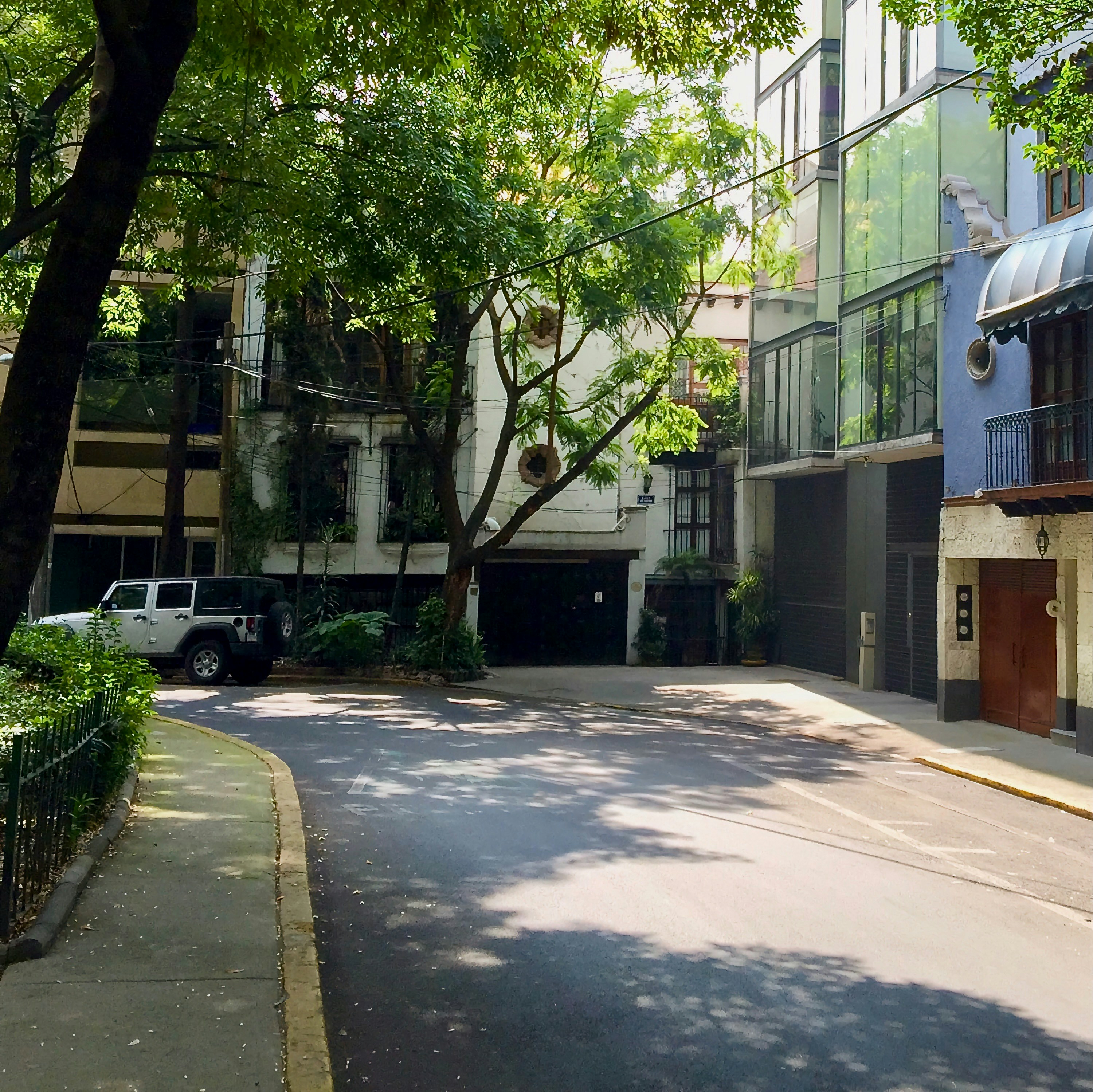 Shaded Street Corridor Between Modern Facades