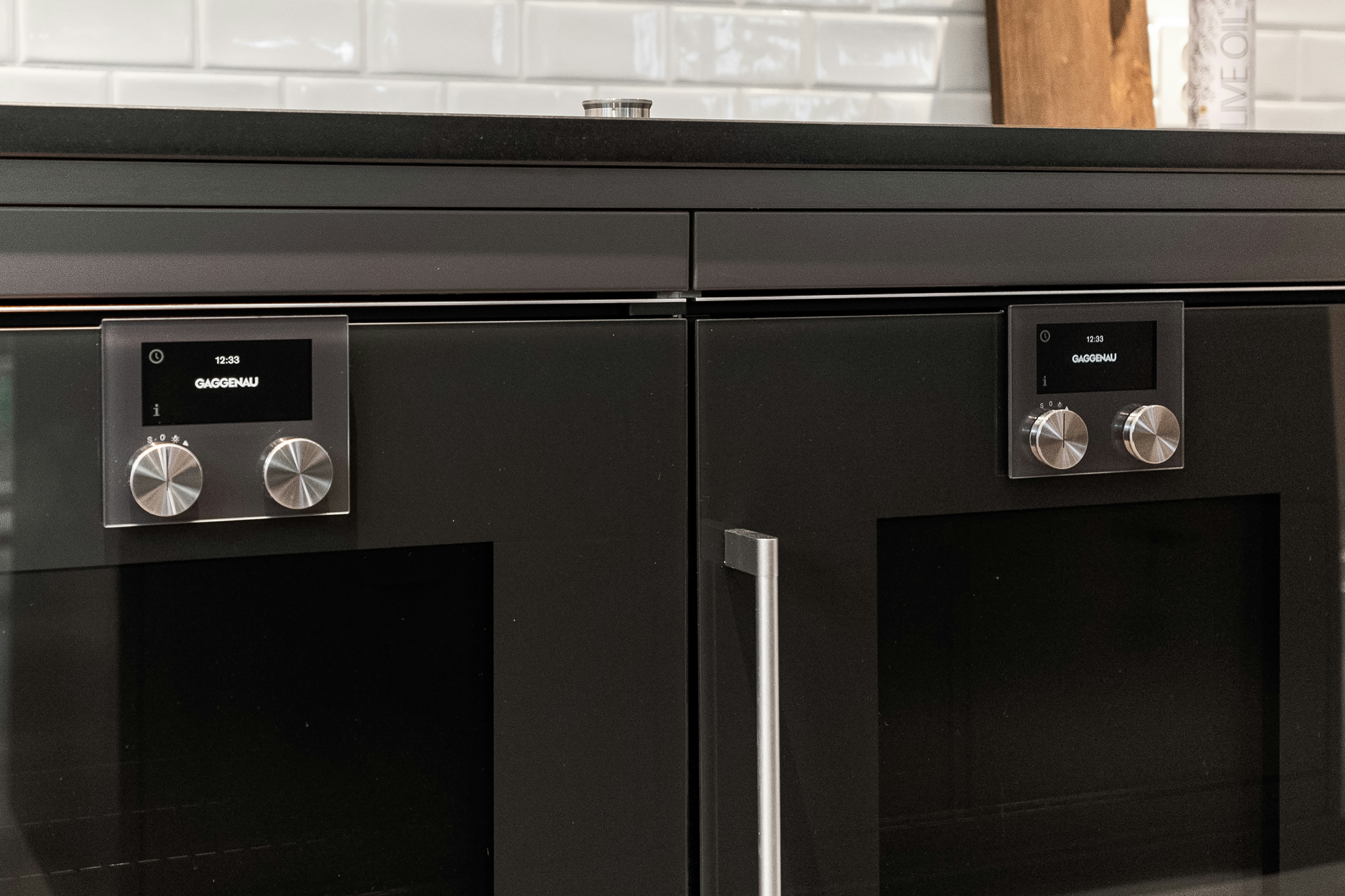 Matte-black Kitchen Ovens with Stainless Knob Detail