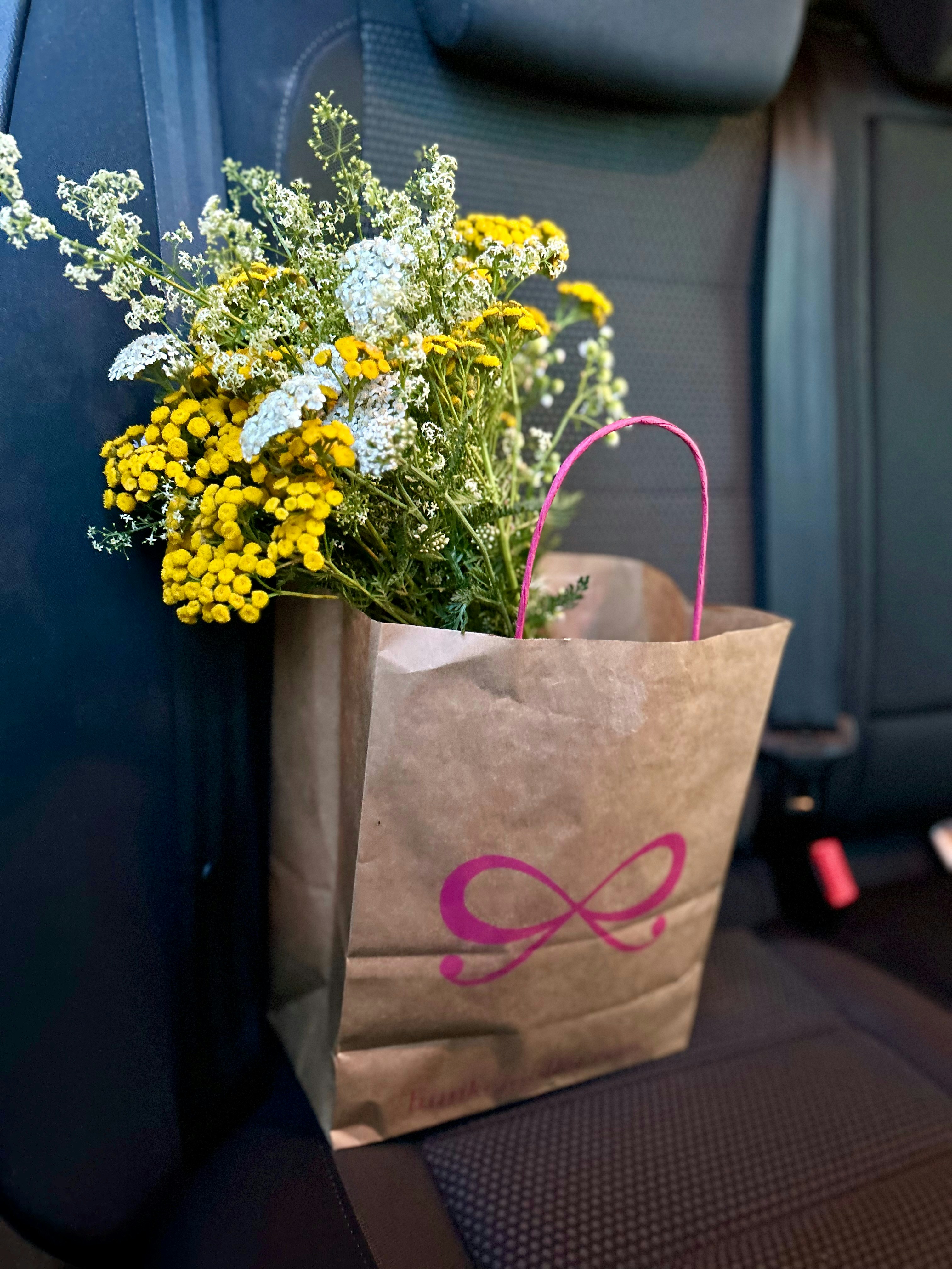 Kraft-Bag Florals: A Quiet Car-Seat Bouquet
