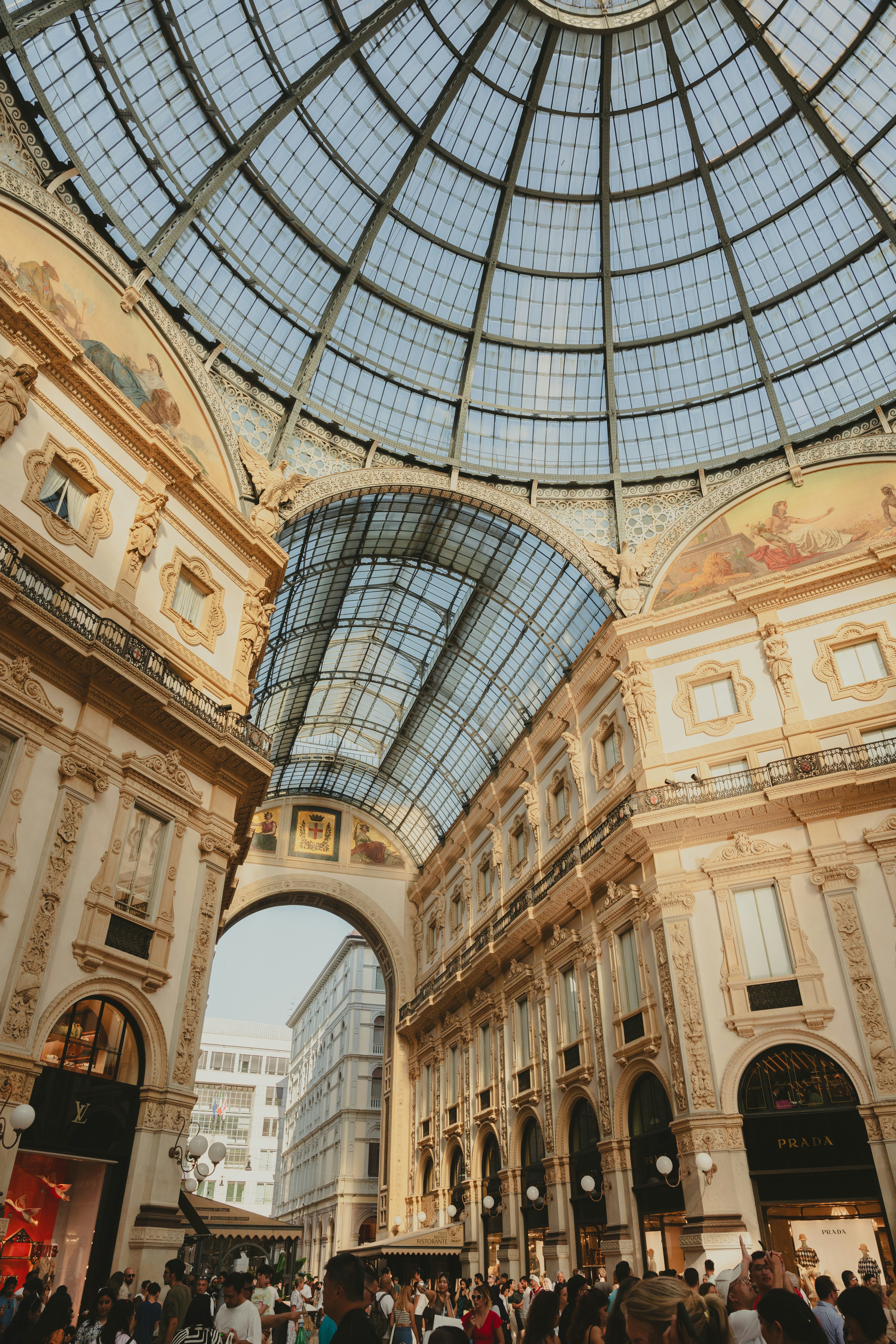A group of people walking around inside of a building photo – Free ...
