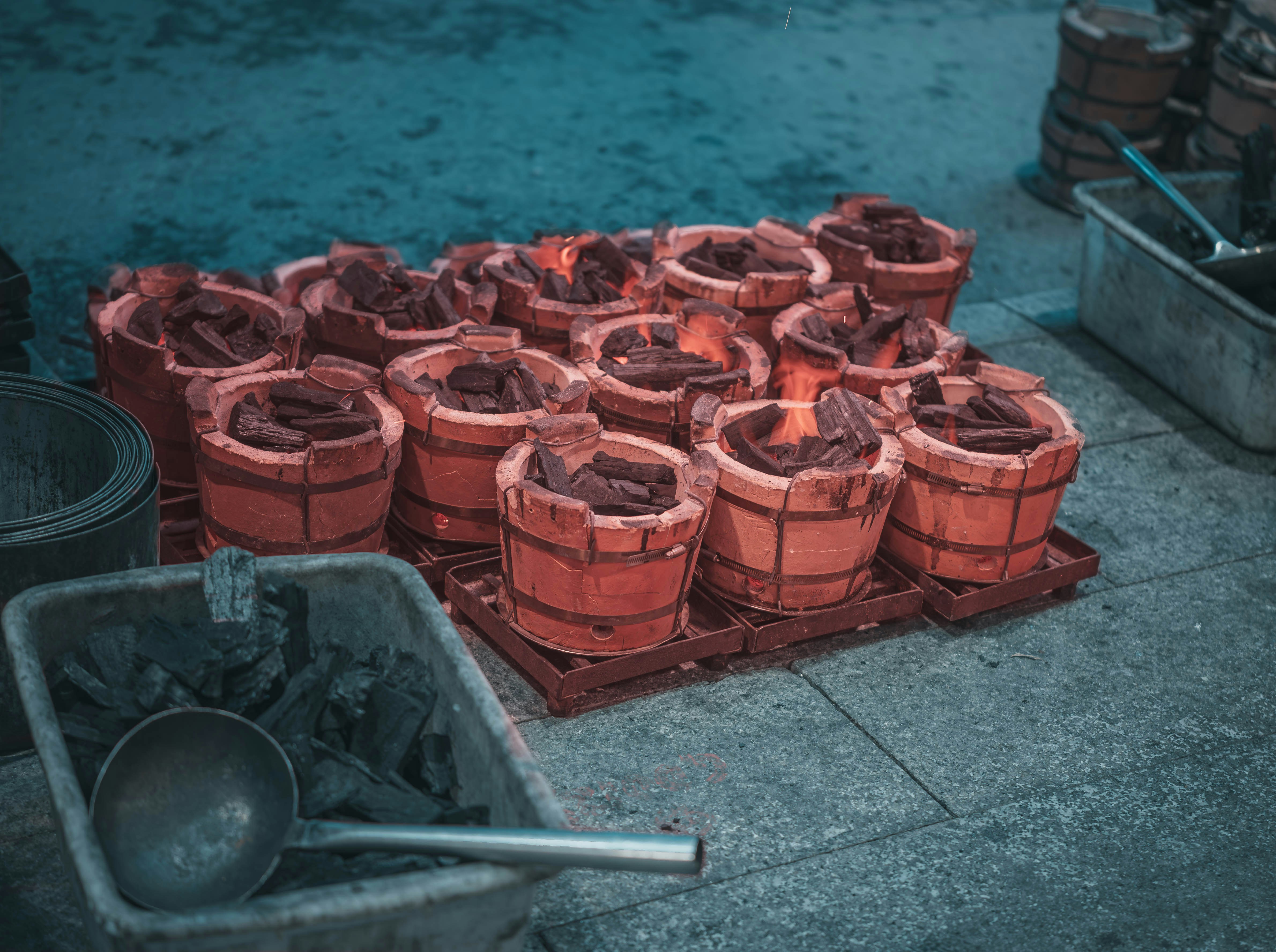 A pile of red pots sitting on top of a sidewalk photo – Free Street ...