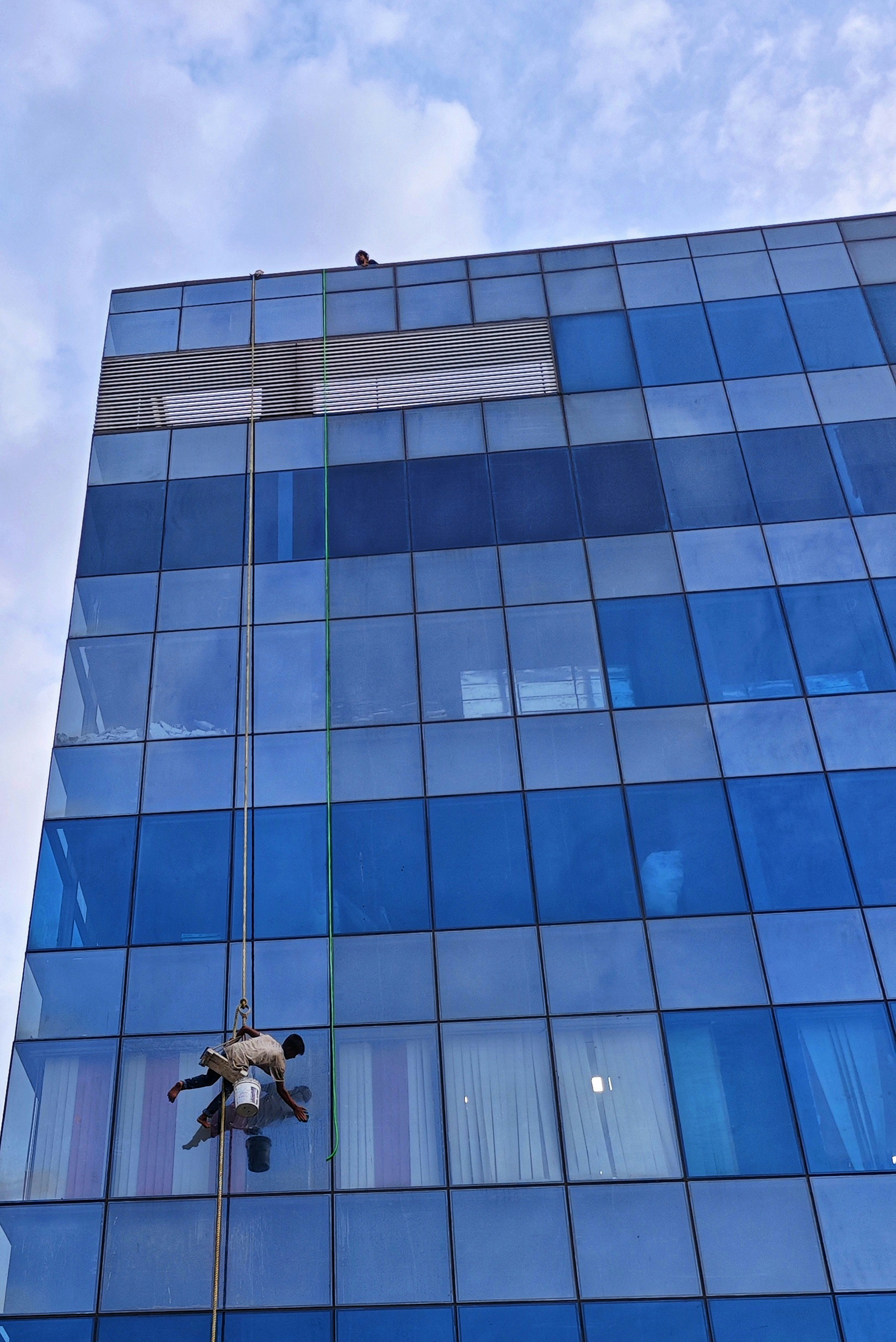 A tall blue building with a street light in front of it photo – Free ...