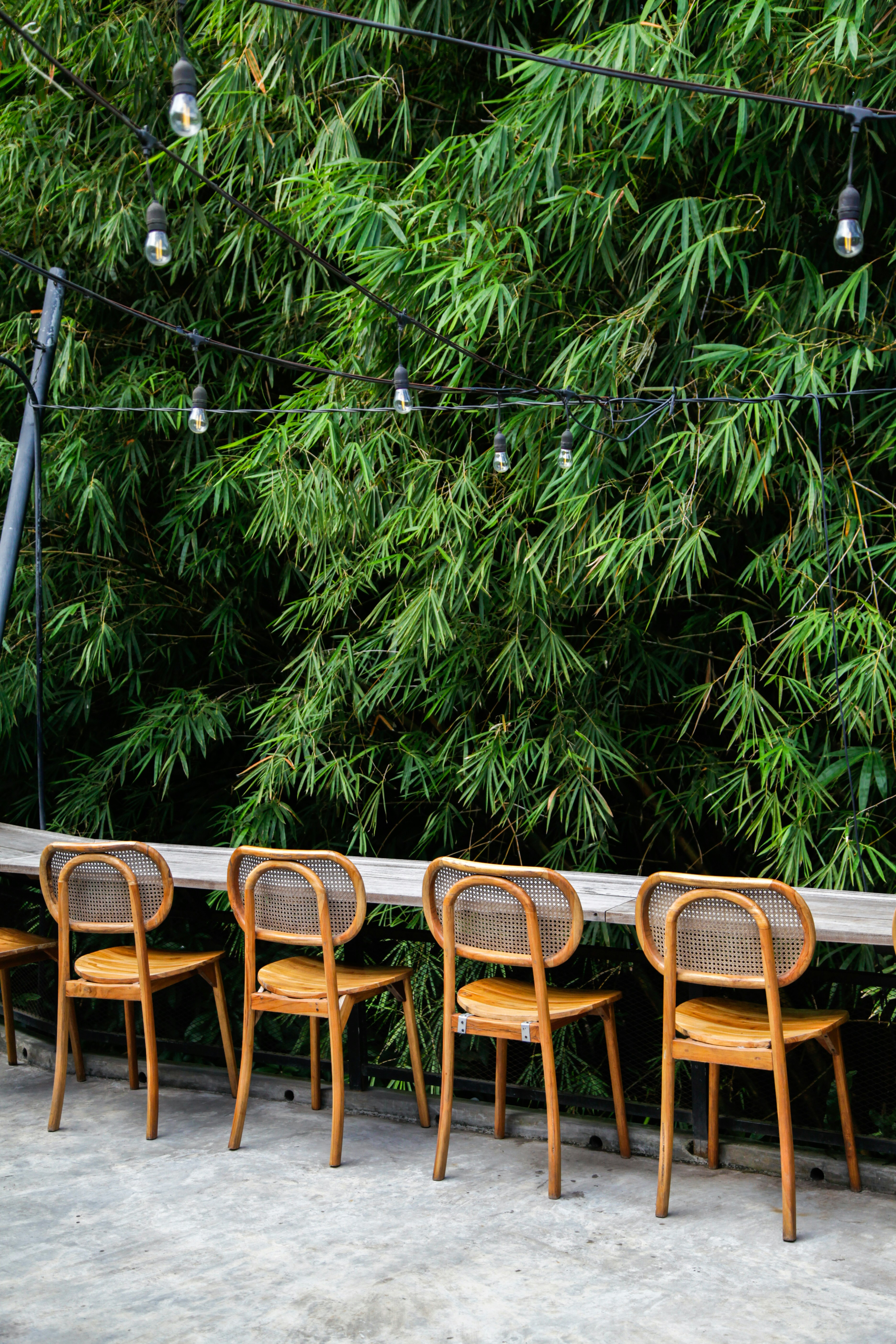 String lights over a weathered outdoor cafe row