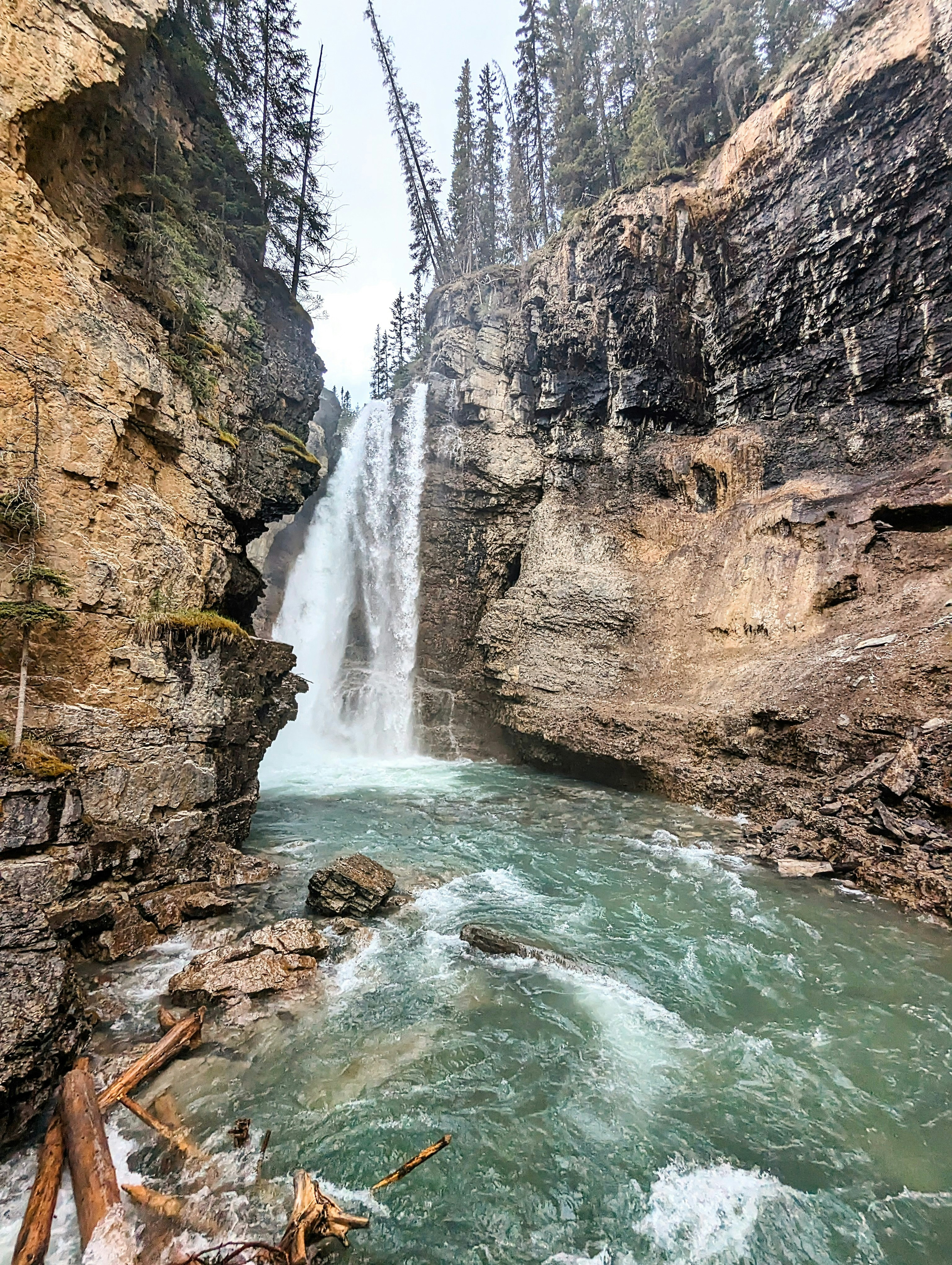 A large waterfall is seen from the side of a cliff photo – Free ...