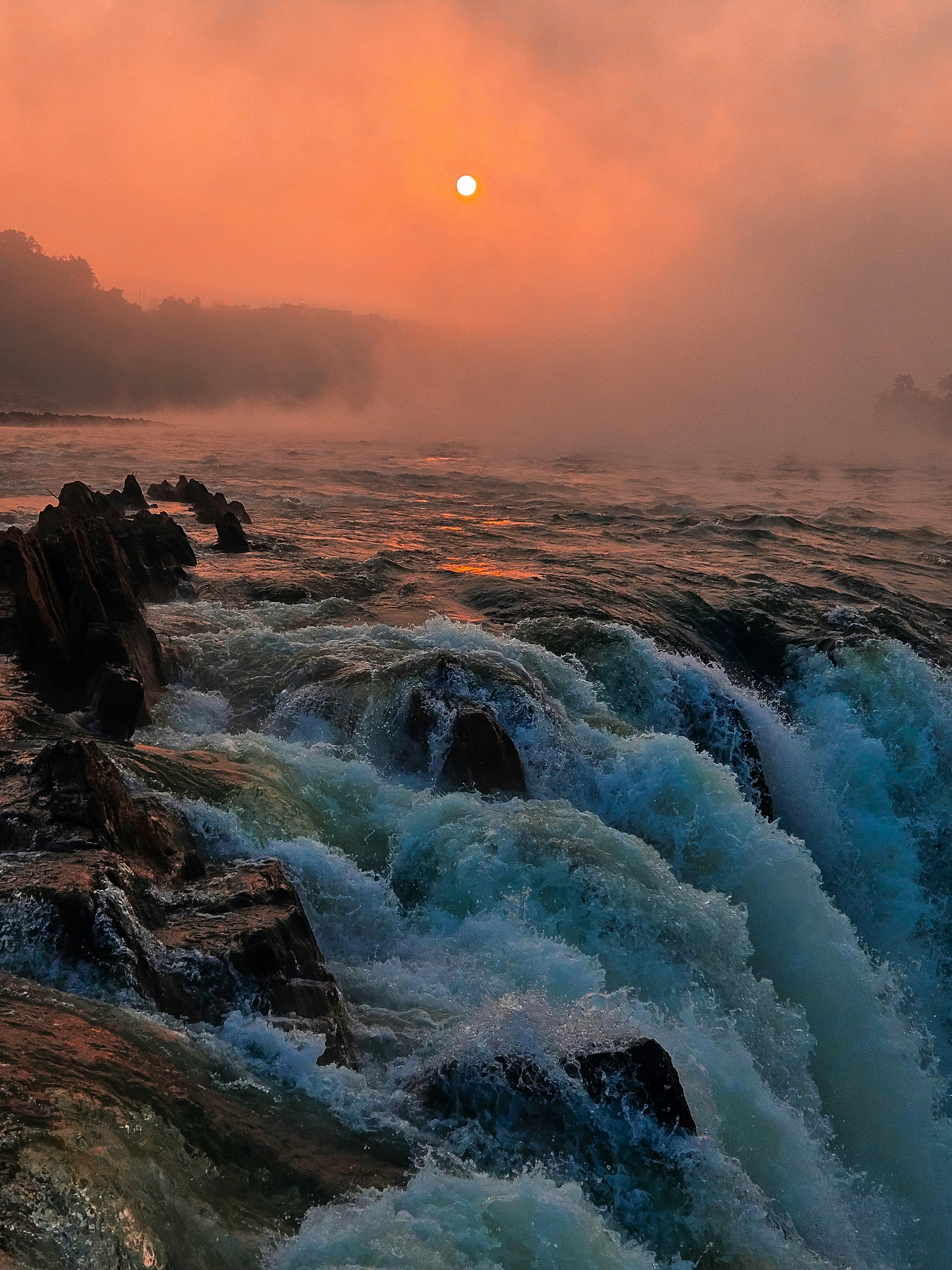 Sunlit Mist Over a Rugged Gorge at Sunset