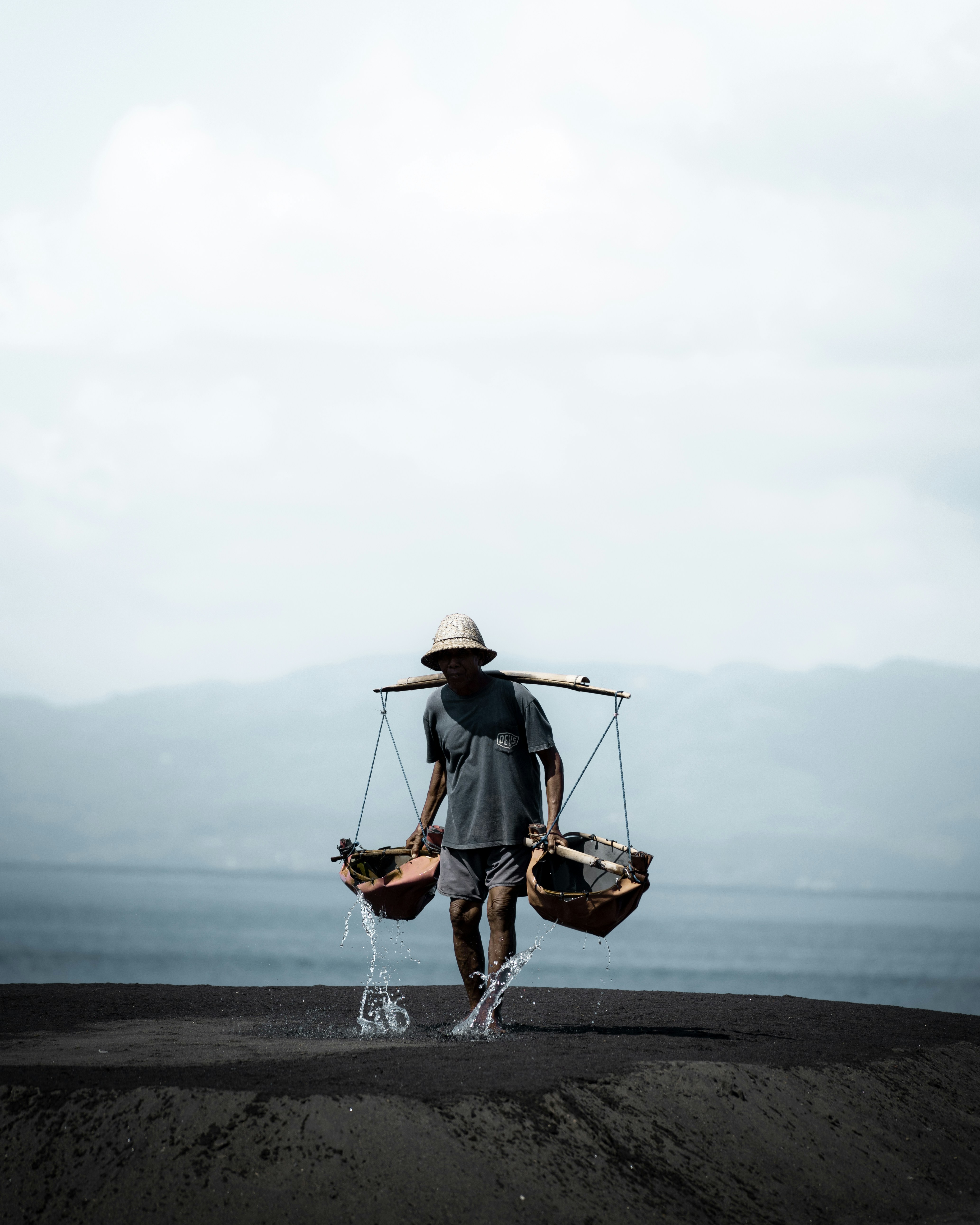 A man carrying two bags on his back photo – Free Portrait Image on Unsplash