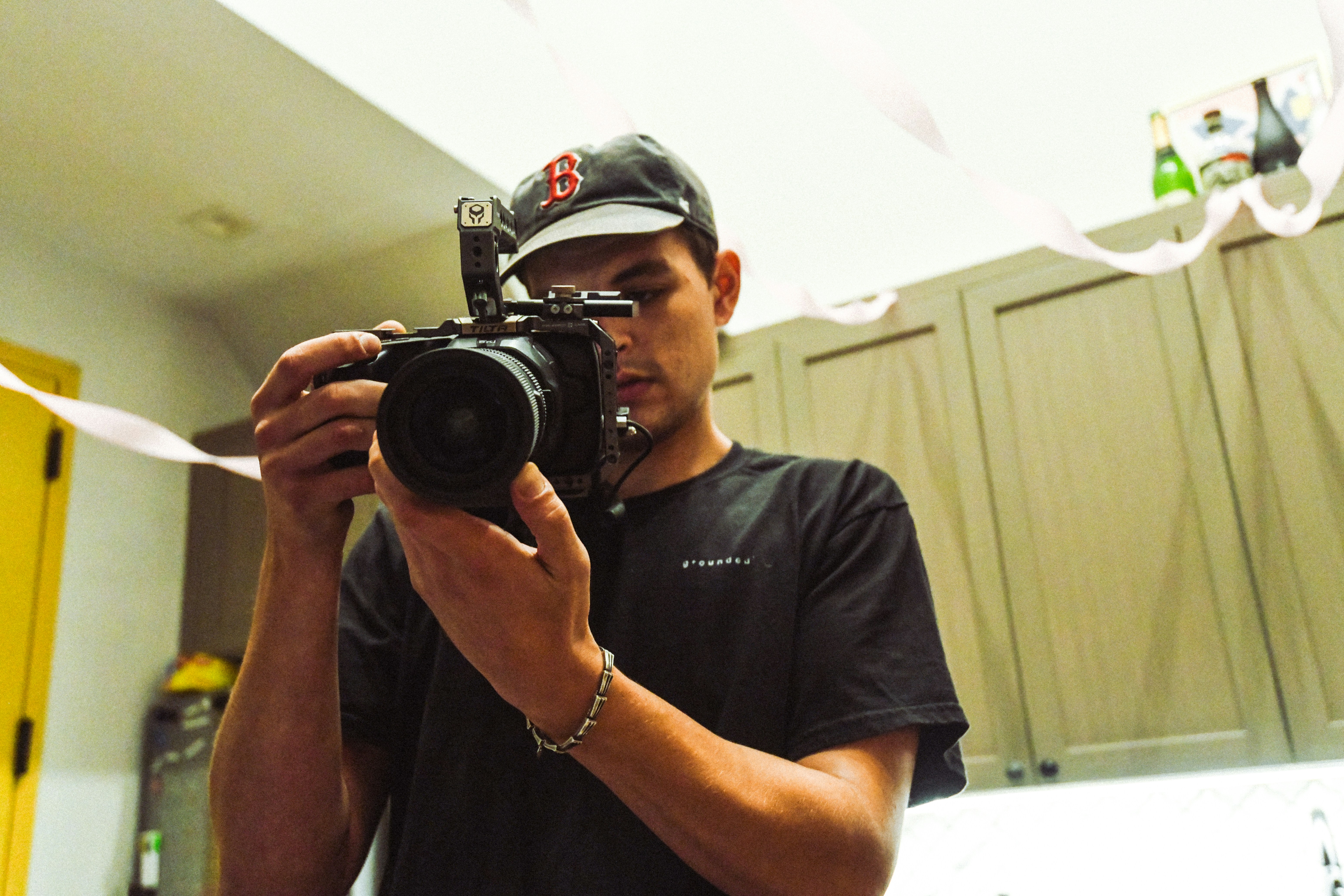 Focused Moments: A Cameraman in the Soft-Glow Kitchen
