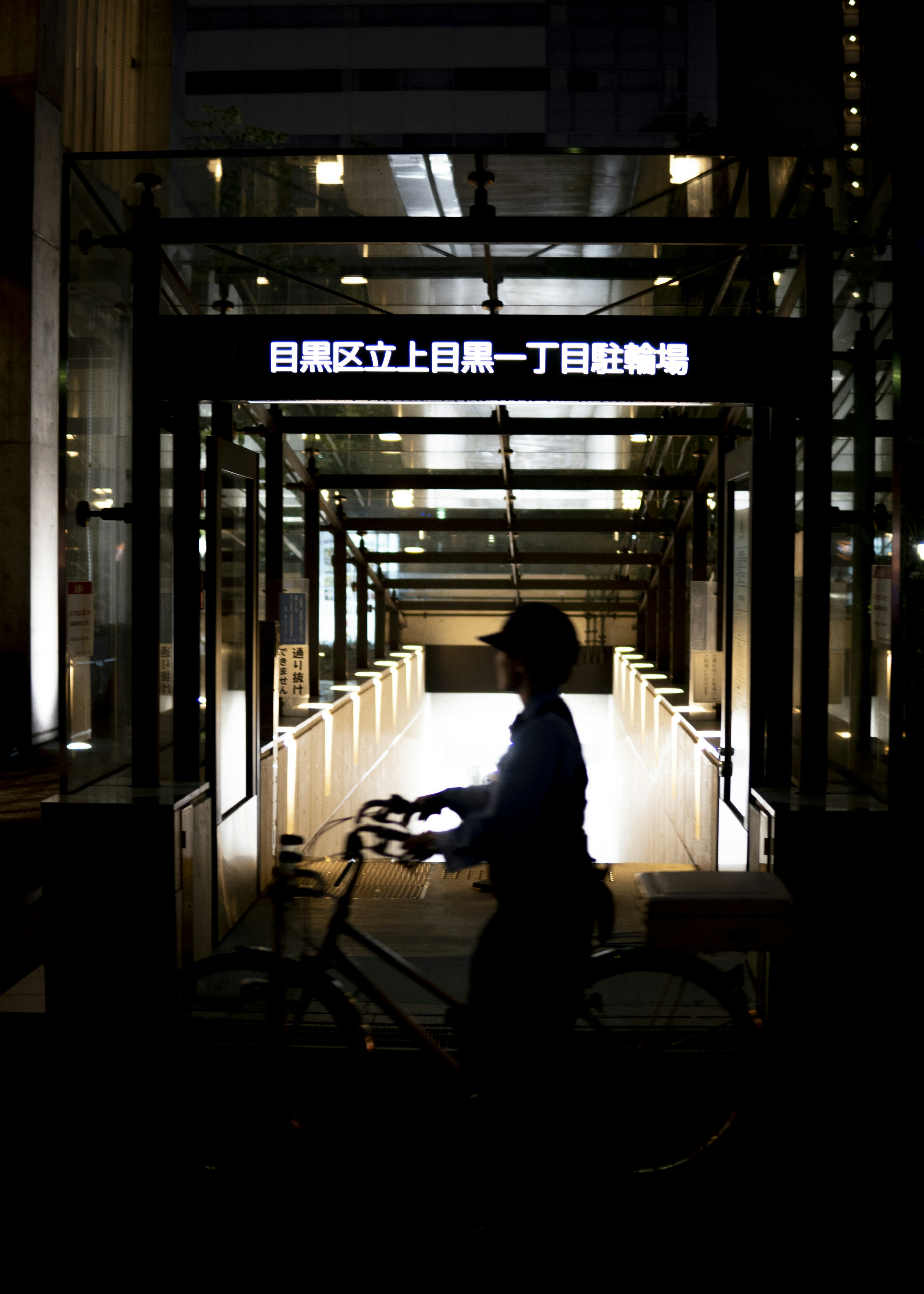 A person riding a bike down a dark hallway