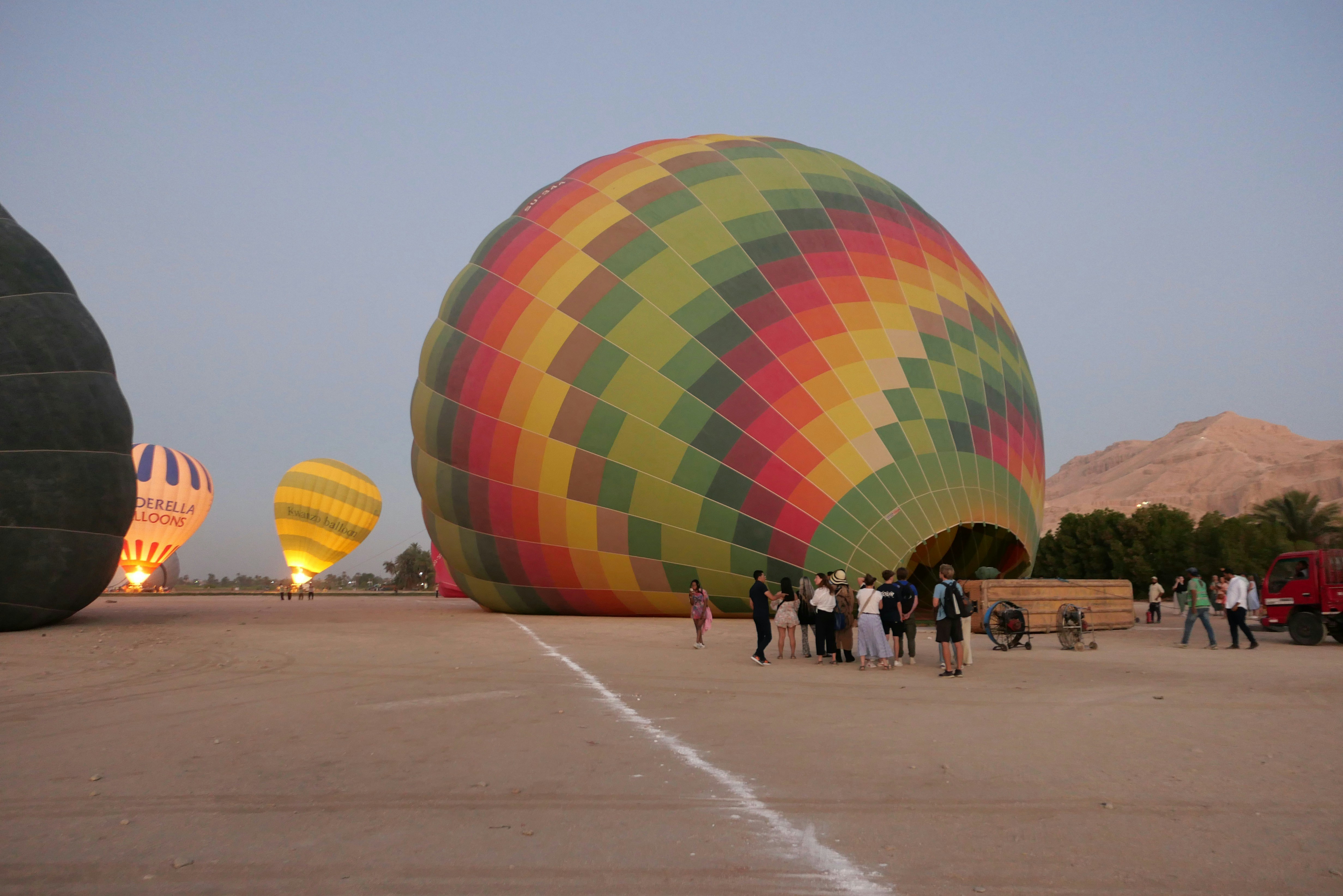 Emergence in the Desert: A Multicolor Balloon Graces the Dunes
