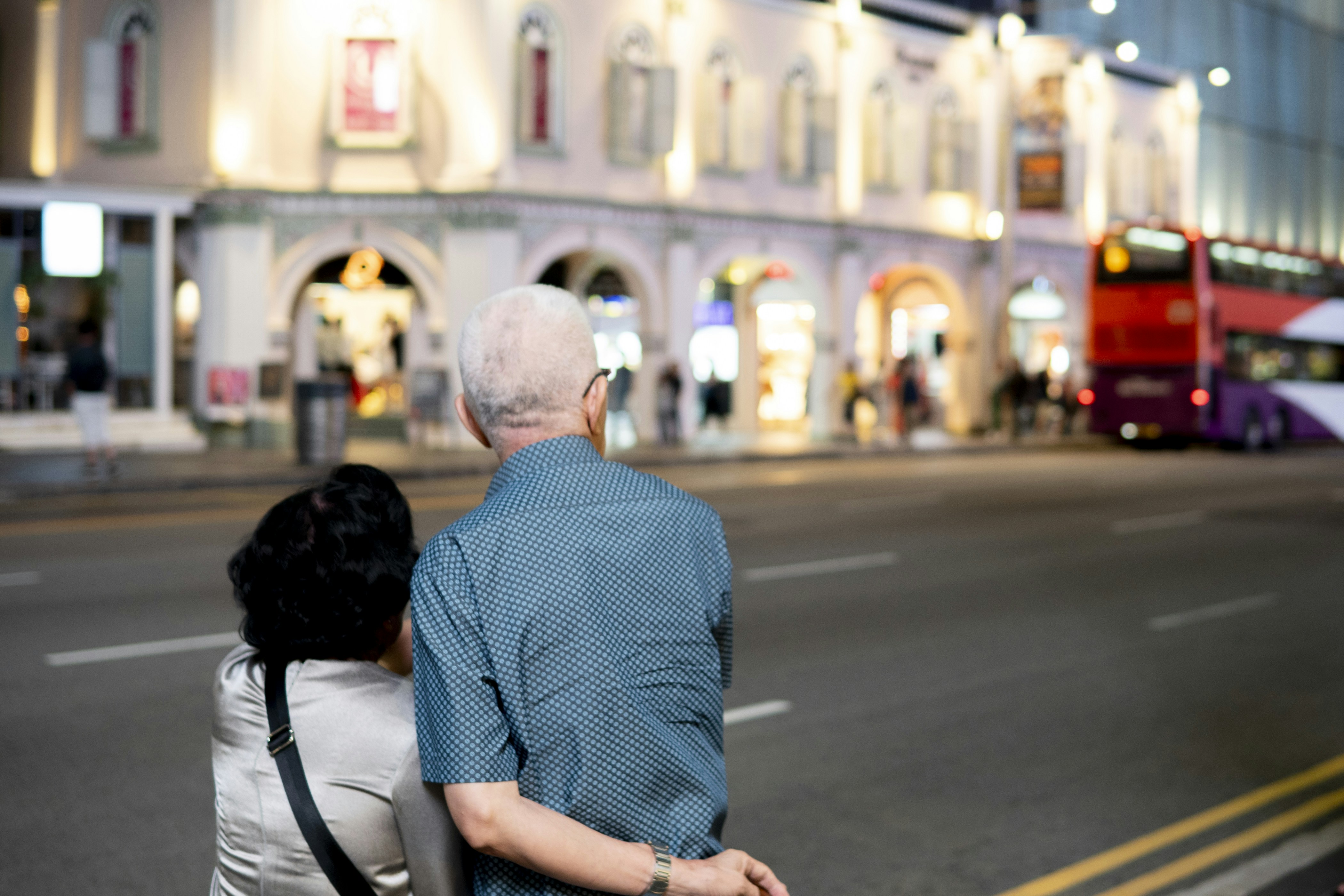 Neon Boulevard Embrace: A Quiet Moment Under City Lights