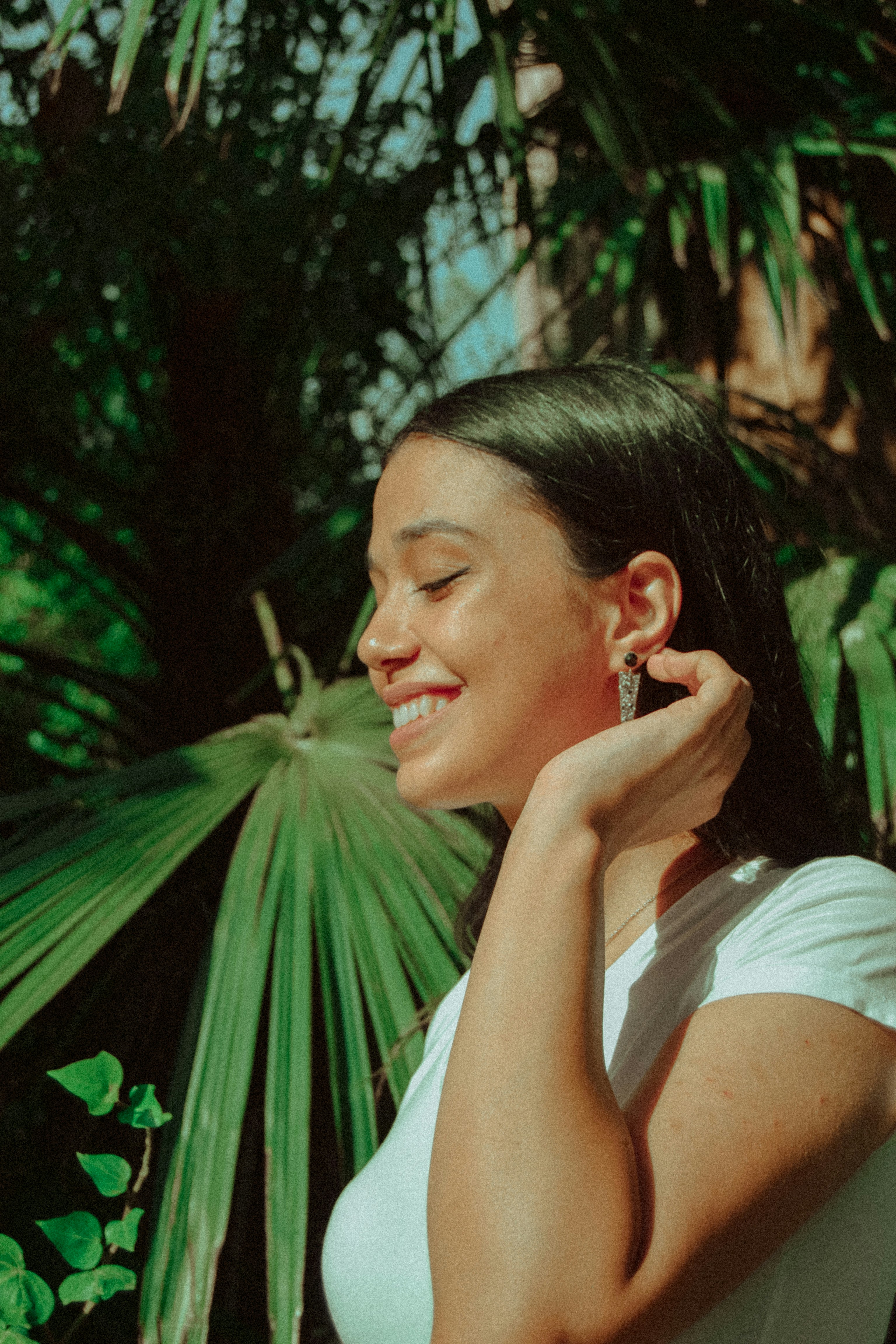 Sunlit Smile Among Palm Fronds: A Quiet Portrait