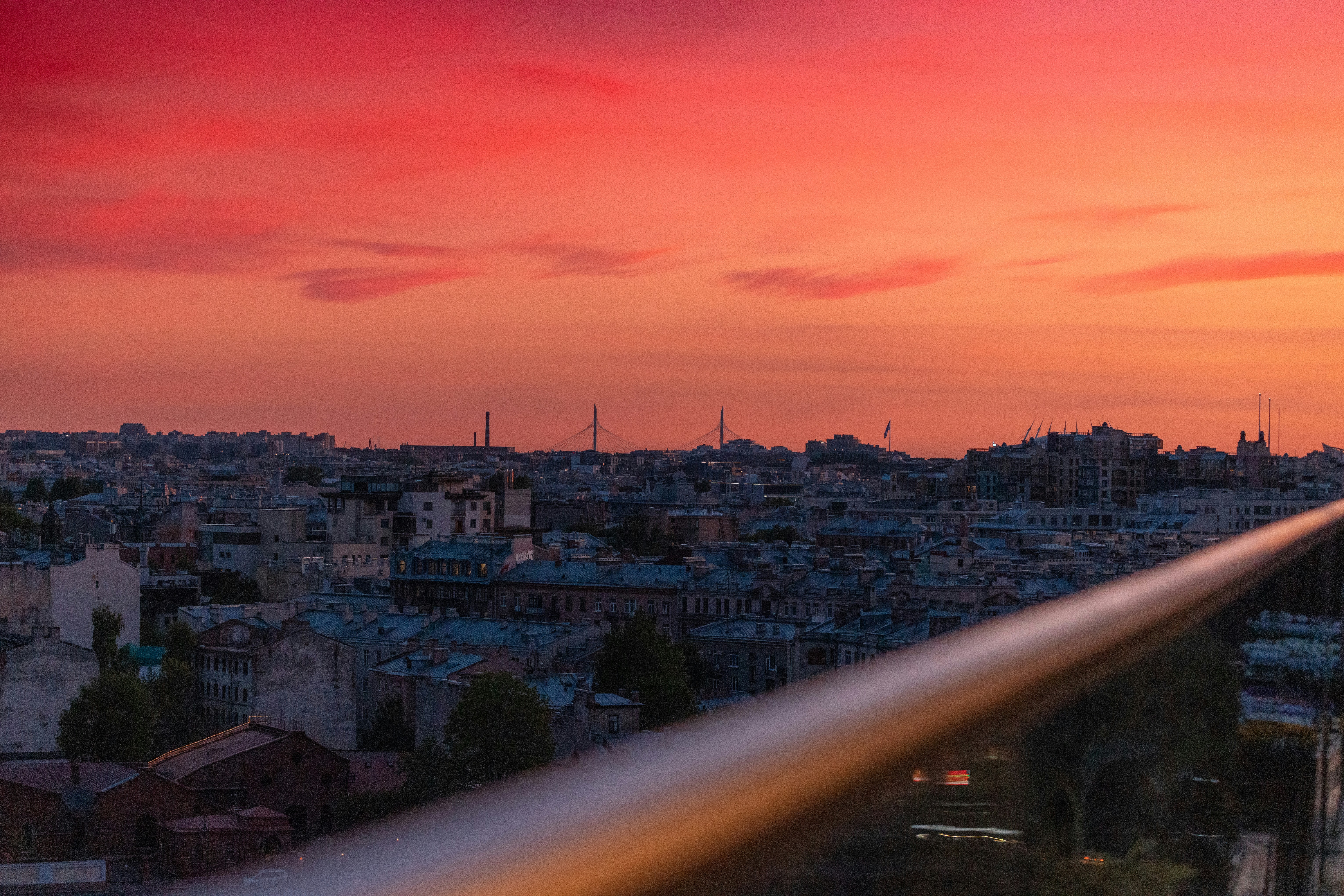 Crimson Dusk Over the City: Turbines at the Horizon